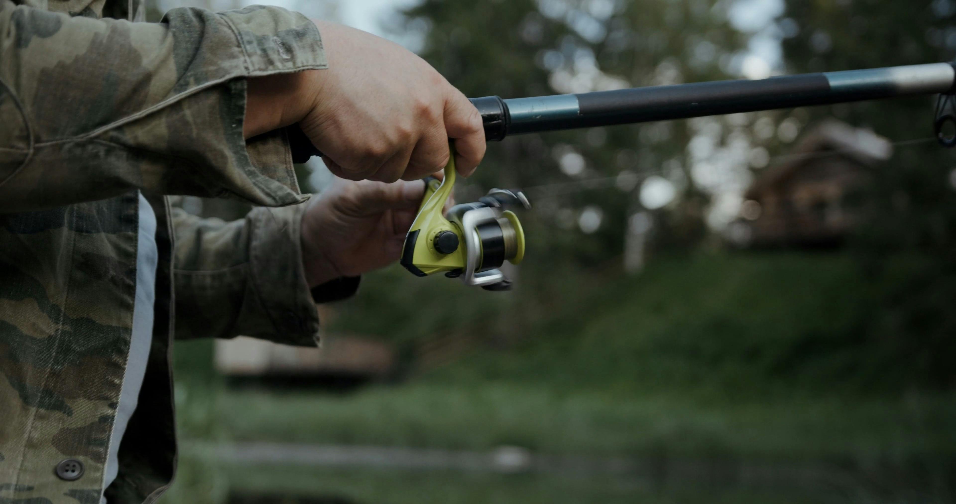 Shallow Focus of Person Reeling in Fishing Line · Free Stock Video