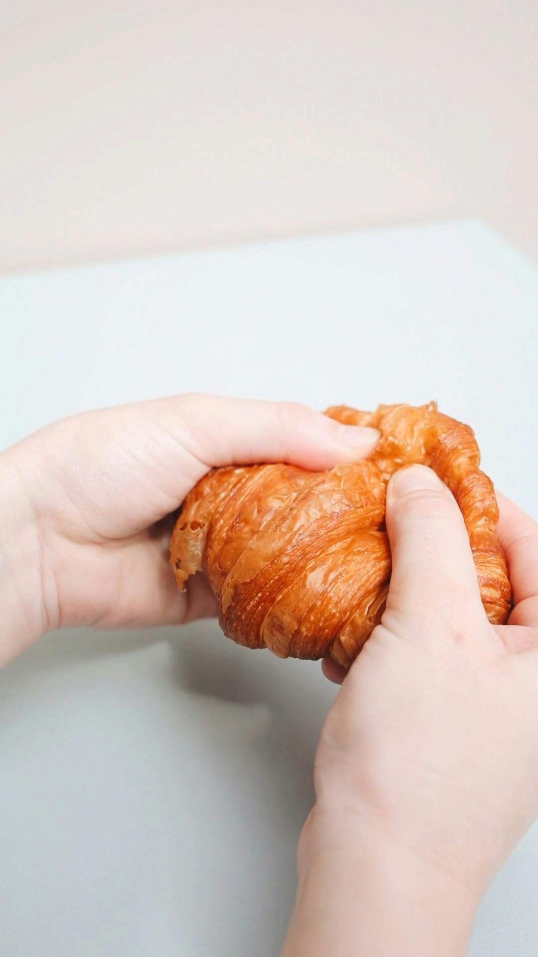 Person Cutting the Croissant in Half · Free Stock Video