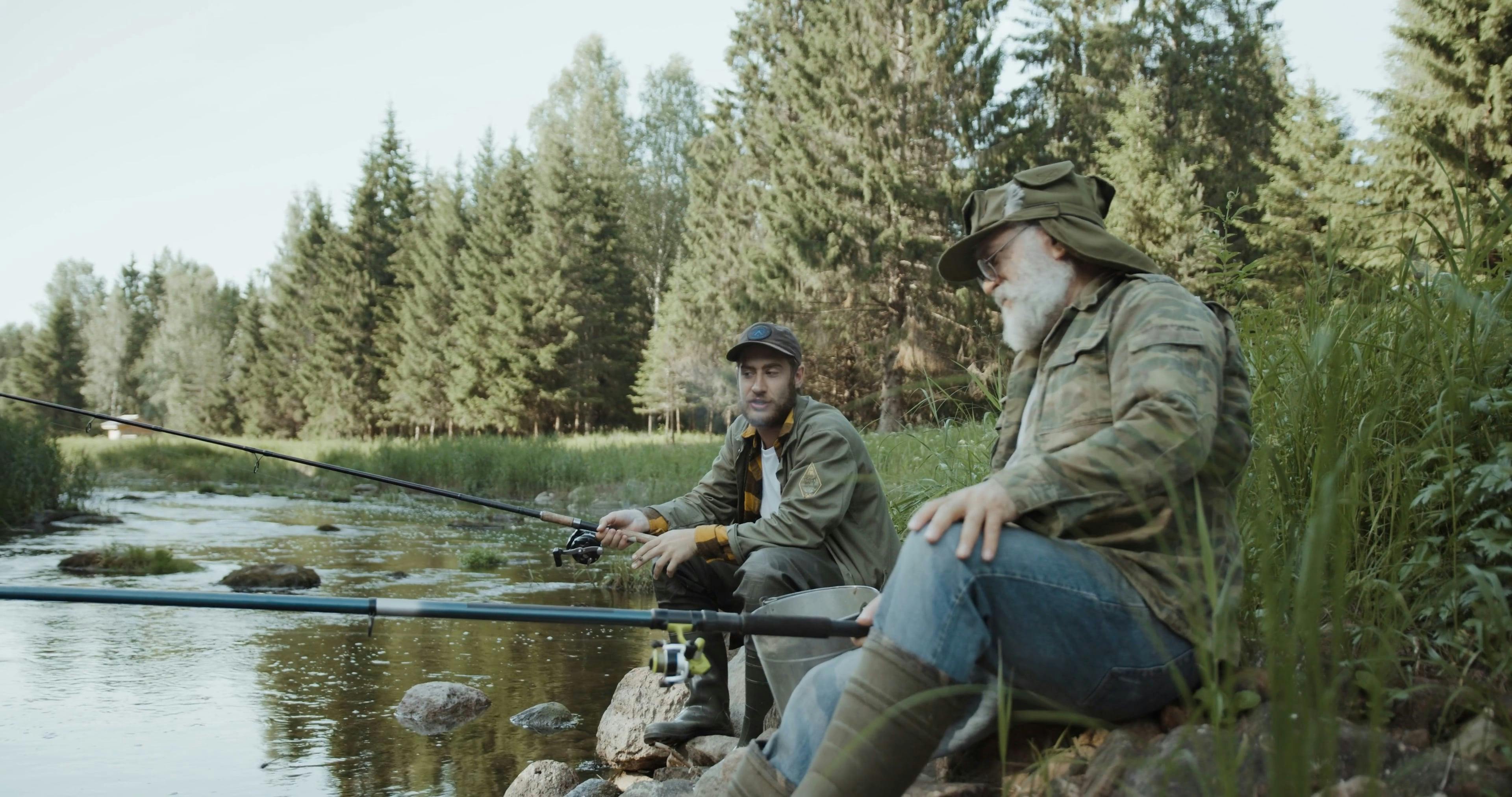 Two Persons Fishing in the River While Talking to Each Other · Free ...