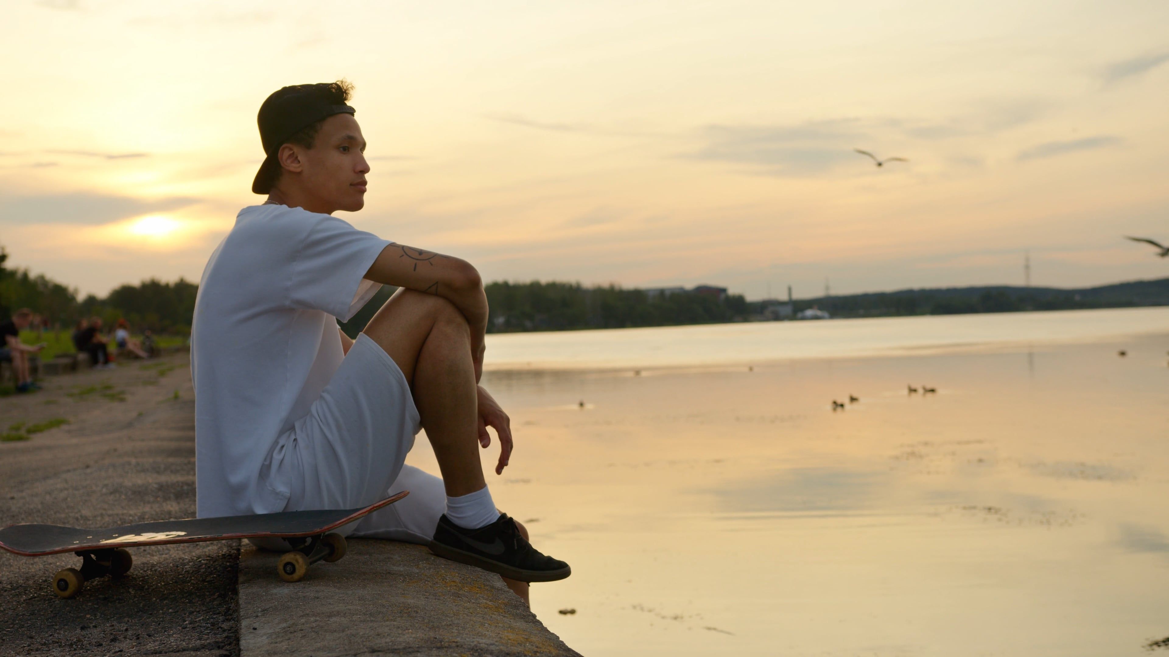A Young Man Resting On The Rip-rap · Free Stock Video