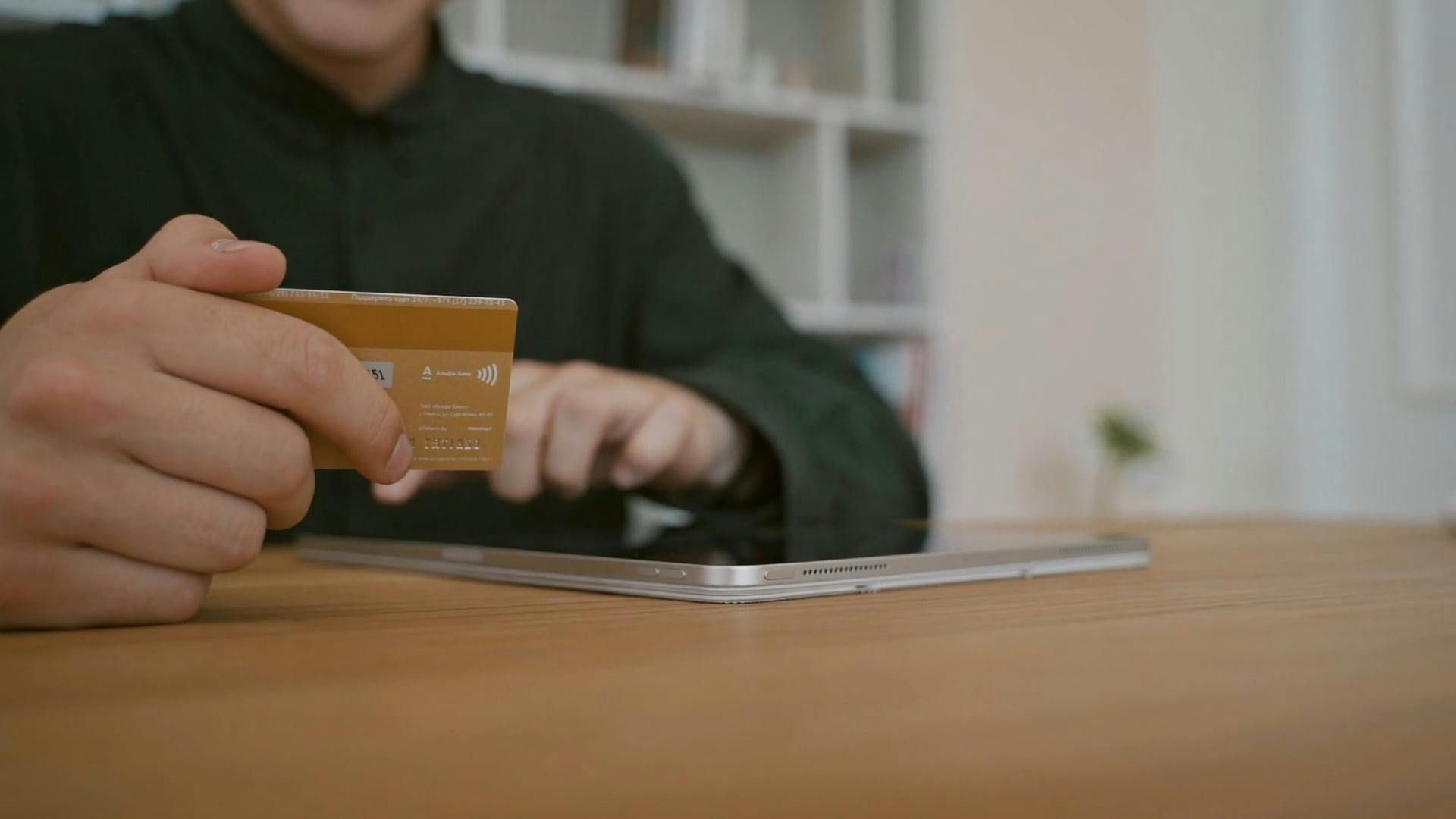 A Woman Doing An On-line Transaction With His Card Using A Laptop Free ...