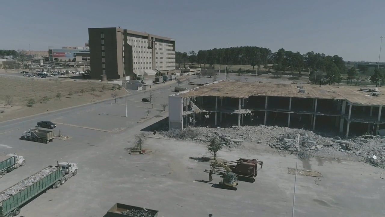 An Aerial Footage of a Building and a Wrecked Building · Free Stock Video