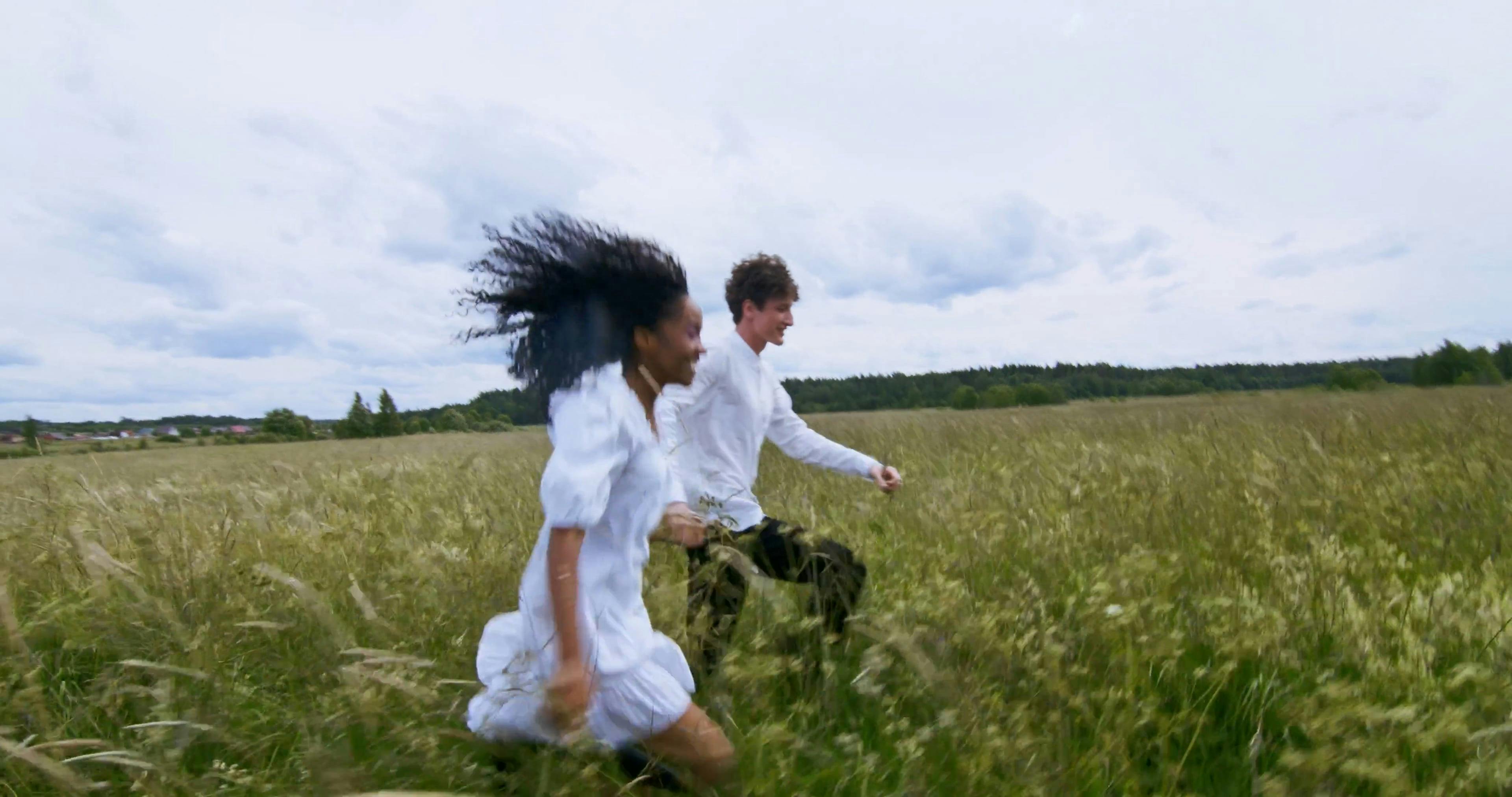 A woman in a white dress running through a field Free Stock Video ...