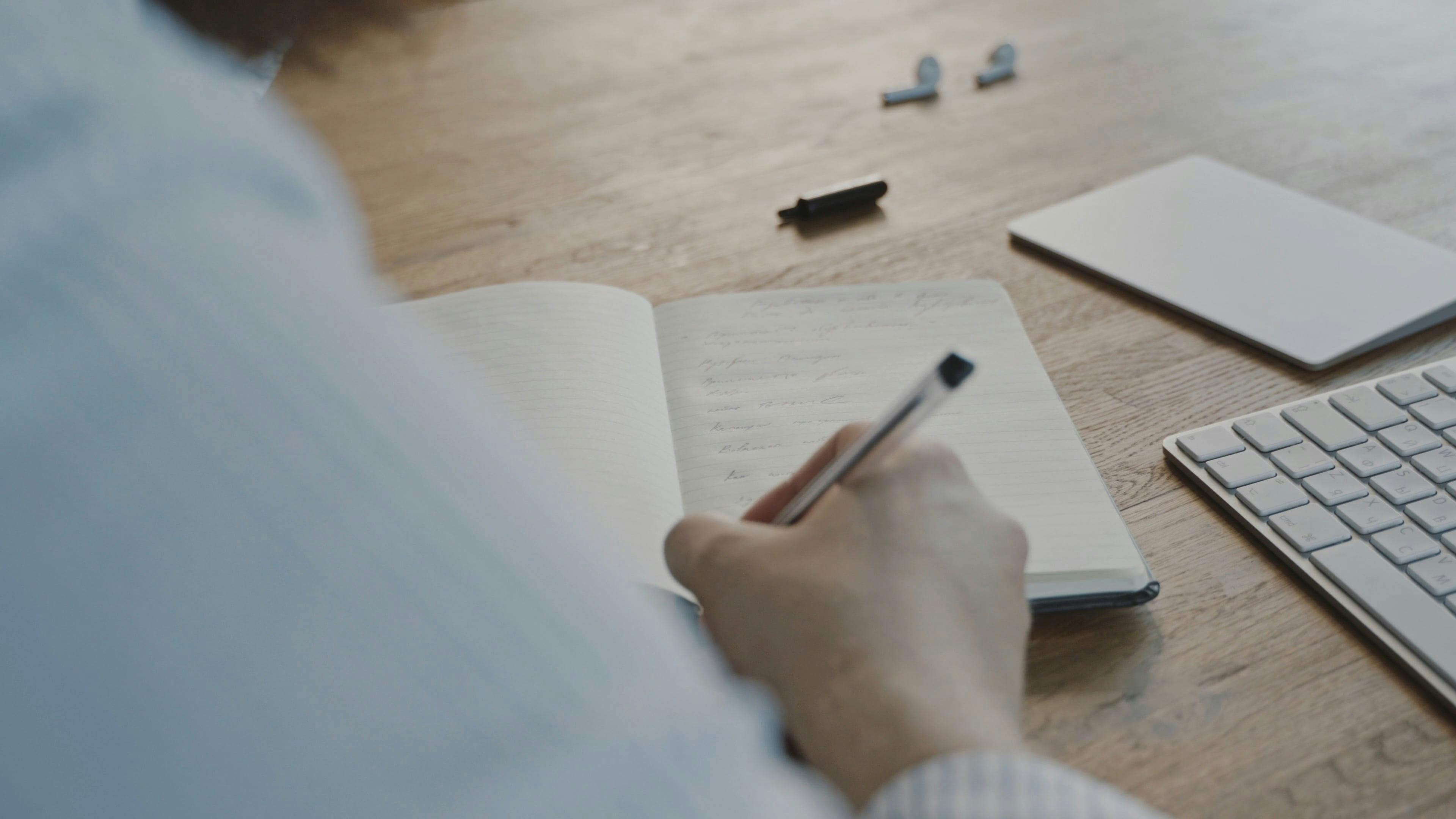 Person Writing on the Notebook · Free Stock Video