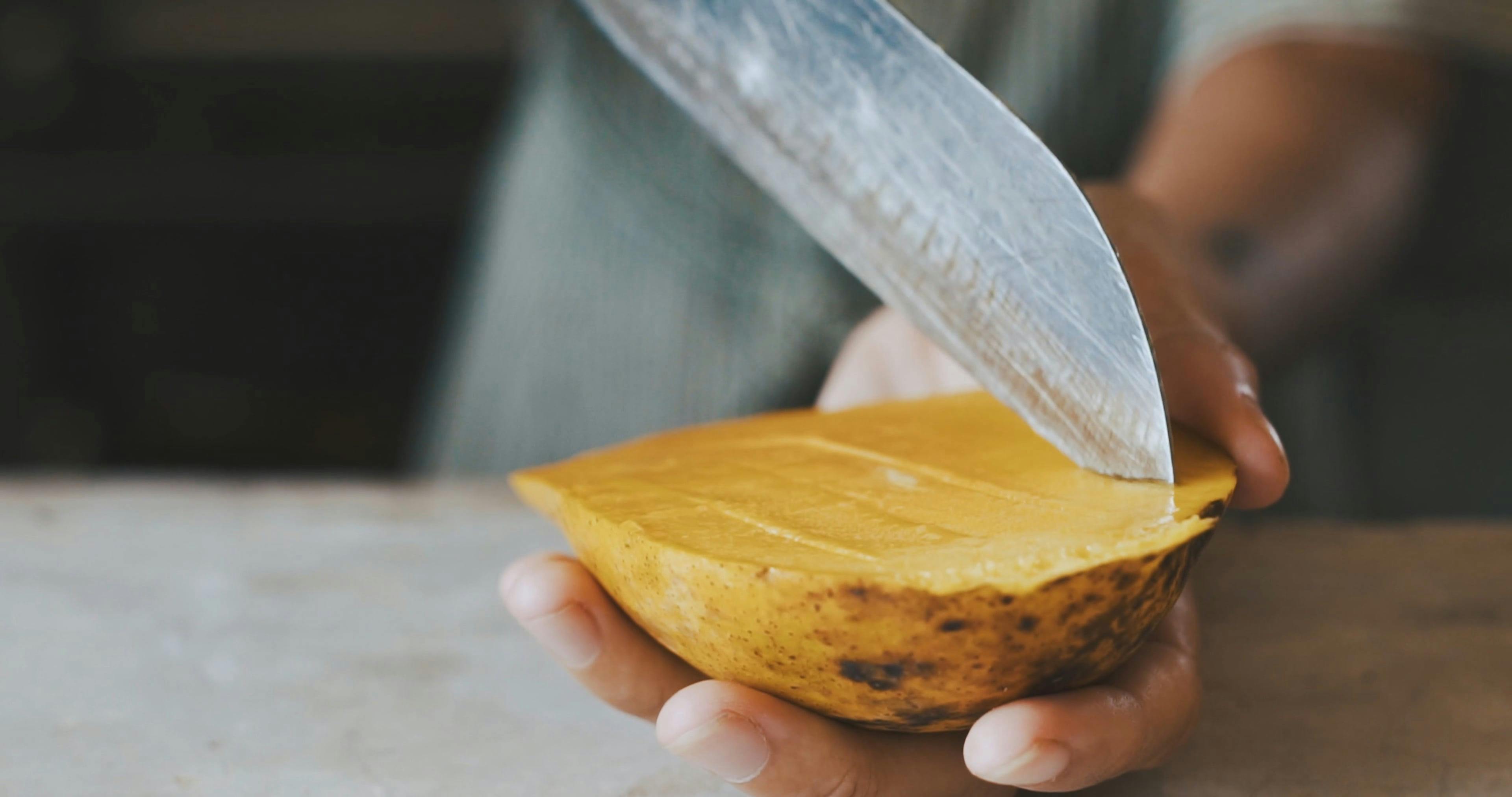 Close-Up View of a Person Slicing a Mango · Free Stock Video