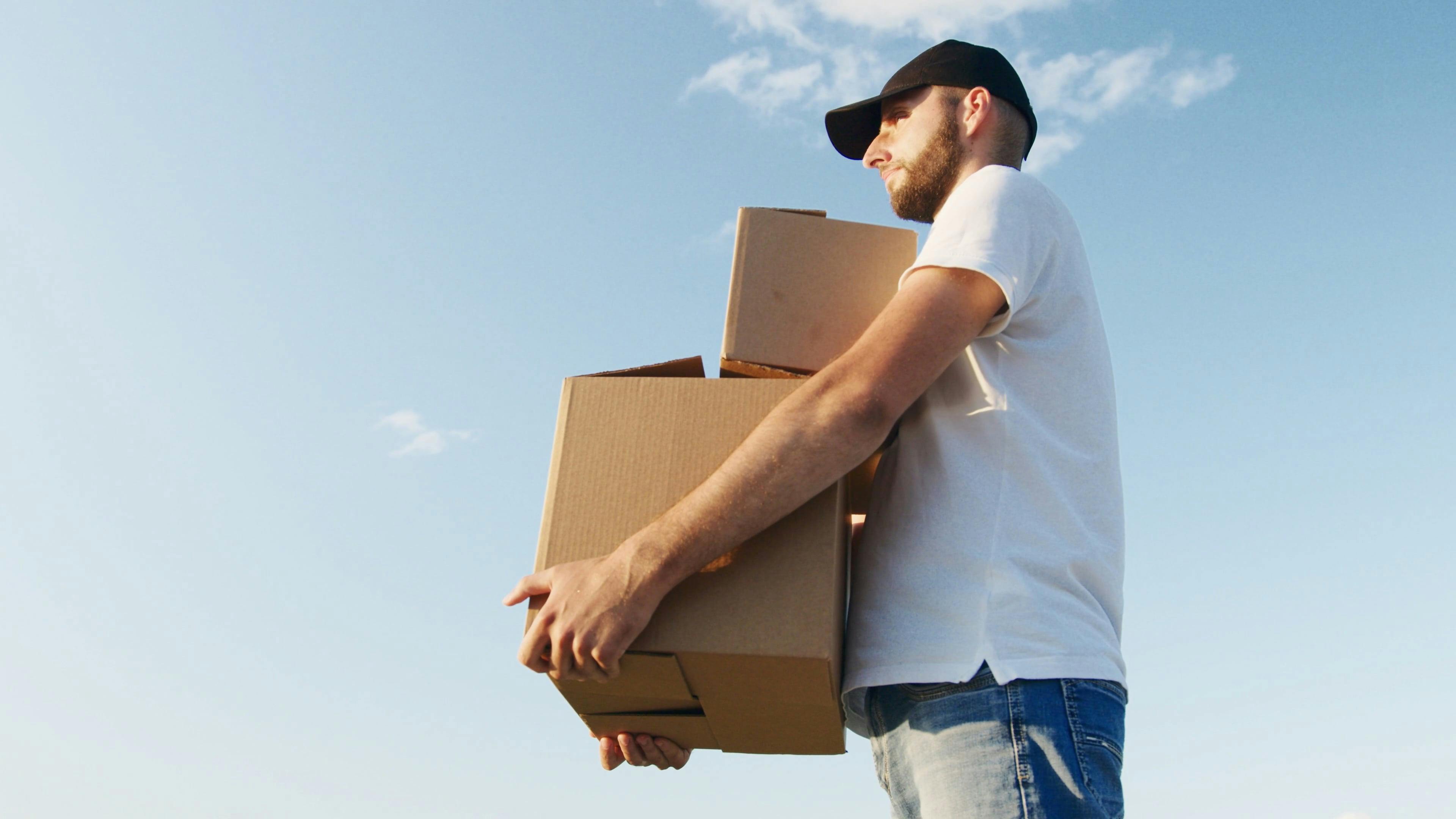 Low-Angle Shot of a Man Carrying Boxes · Free Stock Video