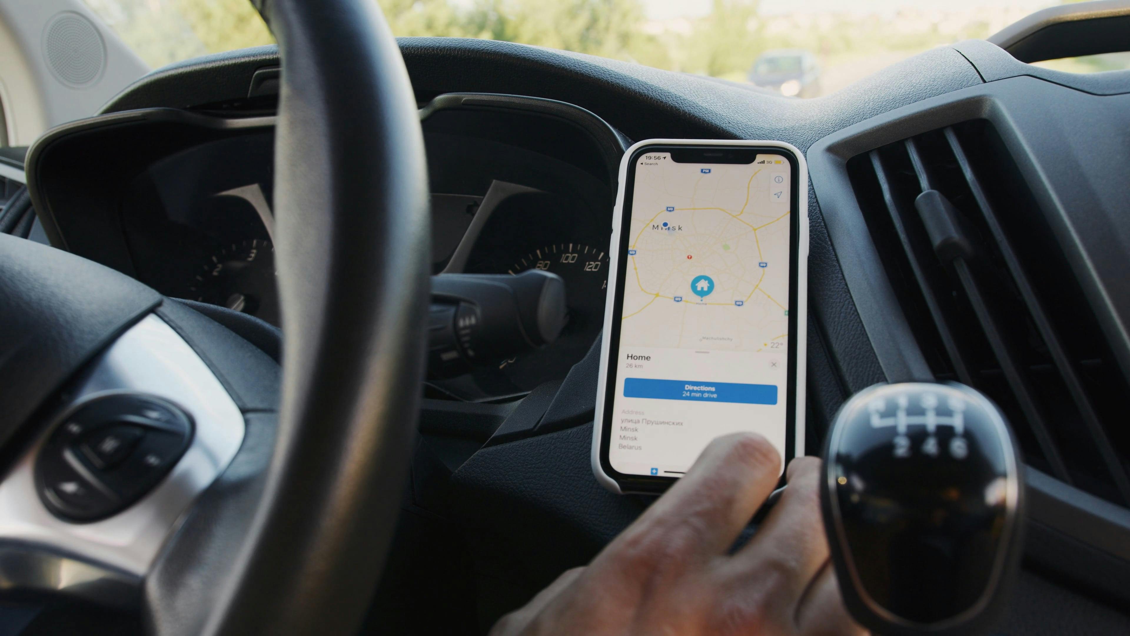 Person Sitting Inside A Car Using GPS Navigation System On A Phone ...