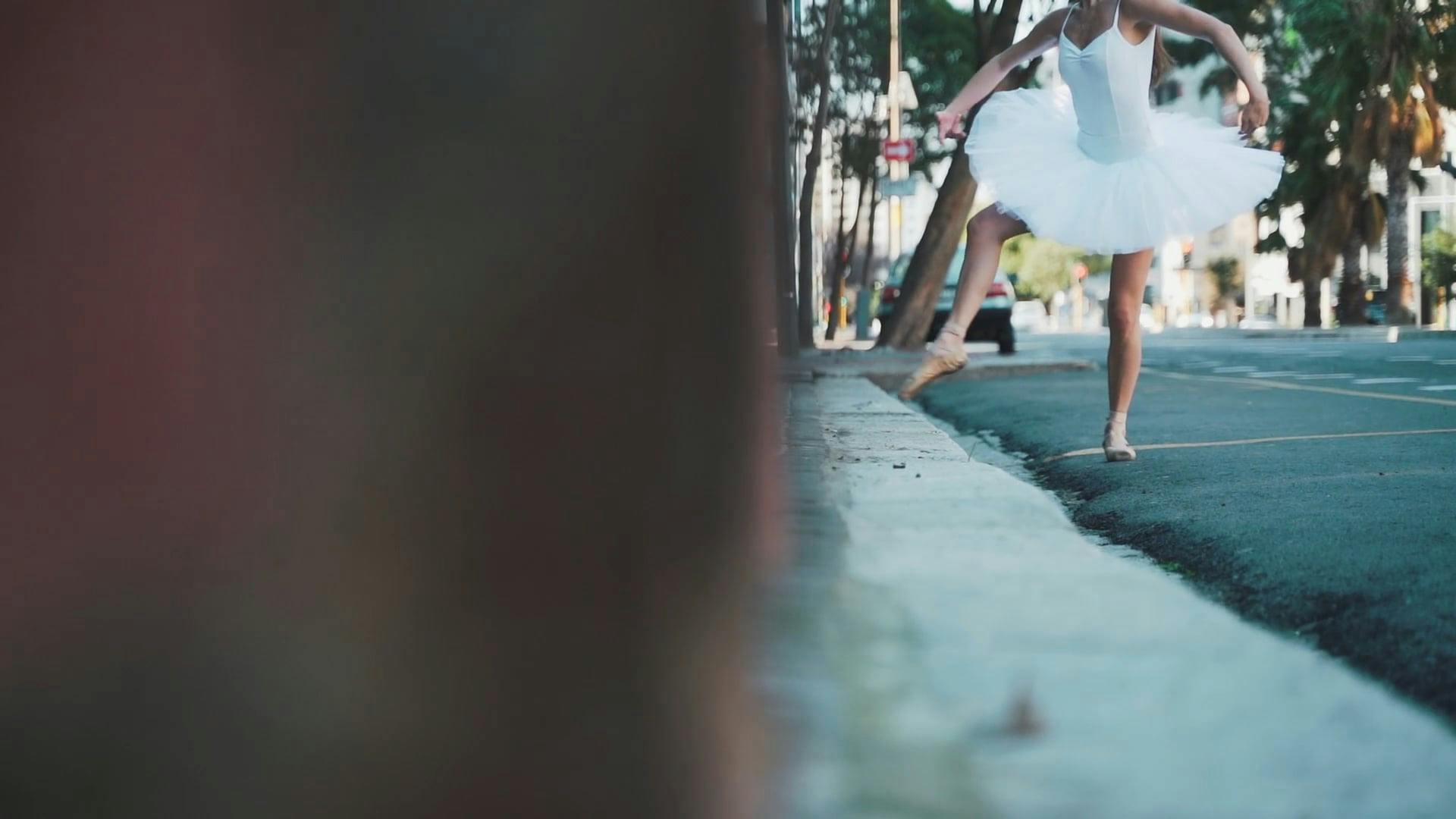 A woman in a white tutu is walking down the street Free Stock Video ...