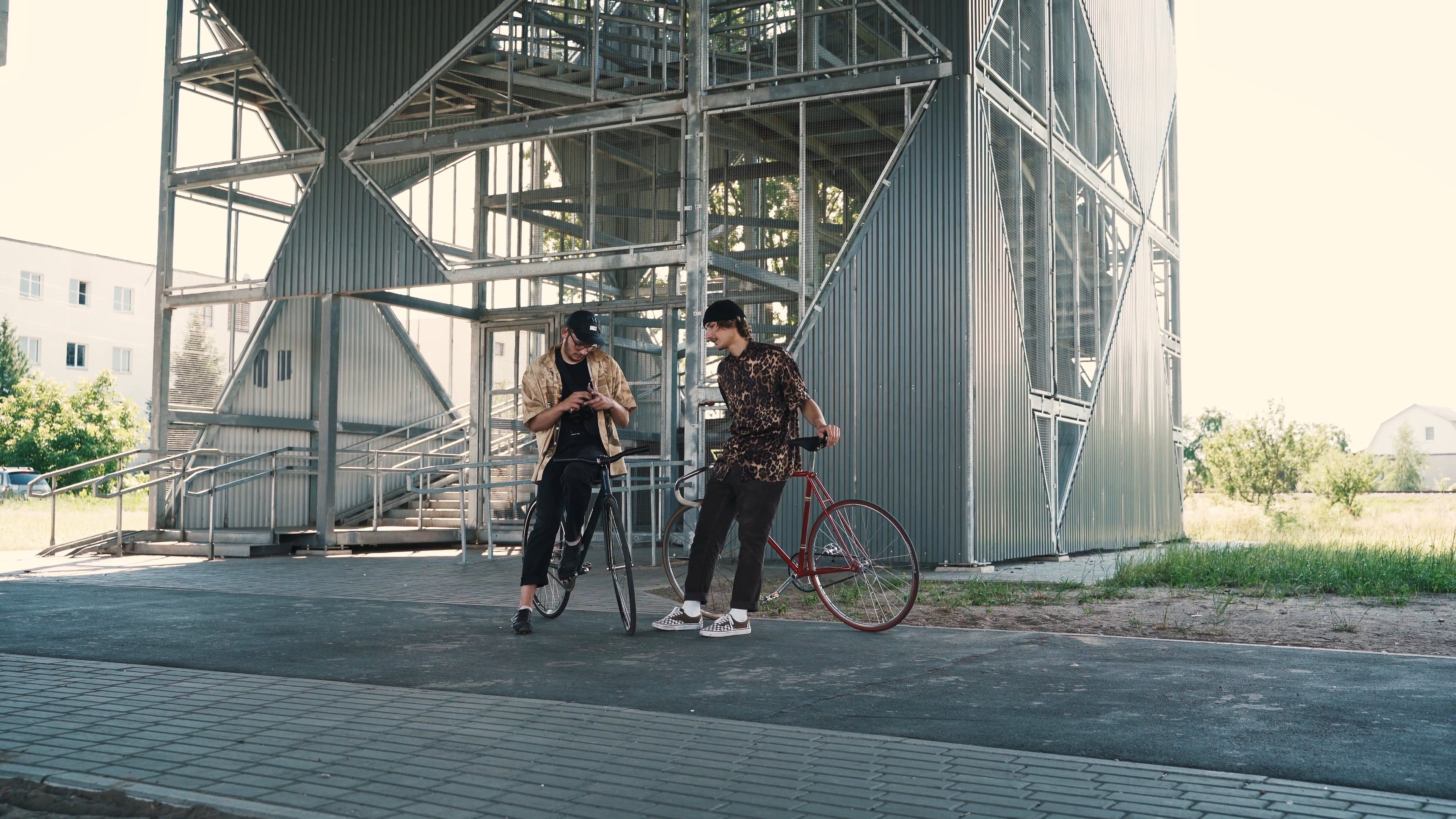 Two Men Having Conversation Under A Bridge With Bicycles · Free Stock Video