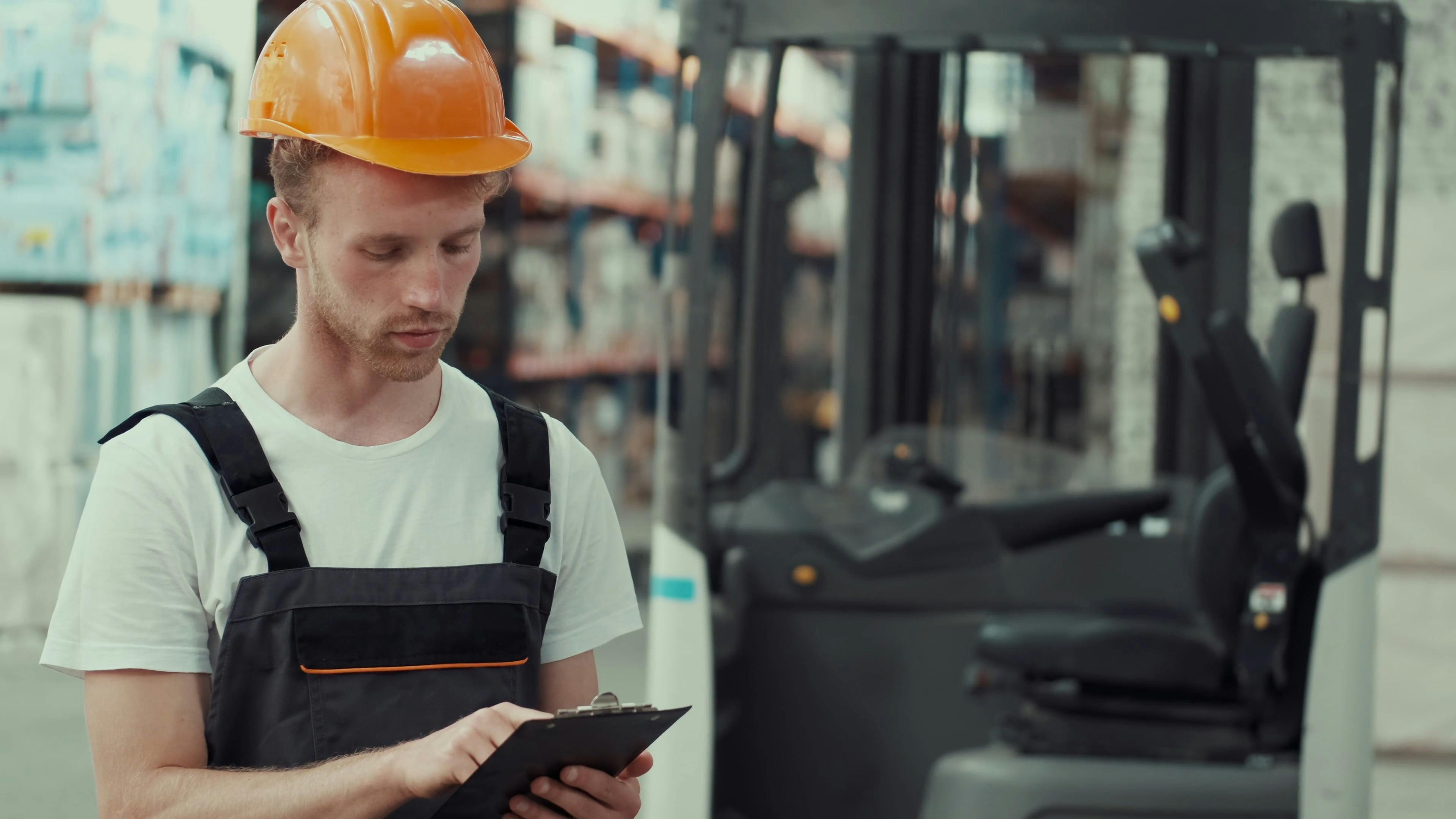 Guy with Safety Helmet Looking into the Checklist Free Stock Video ...