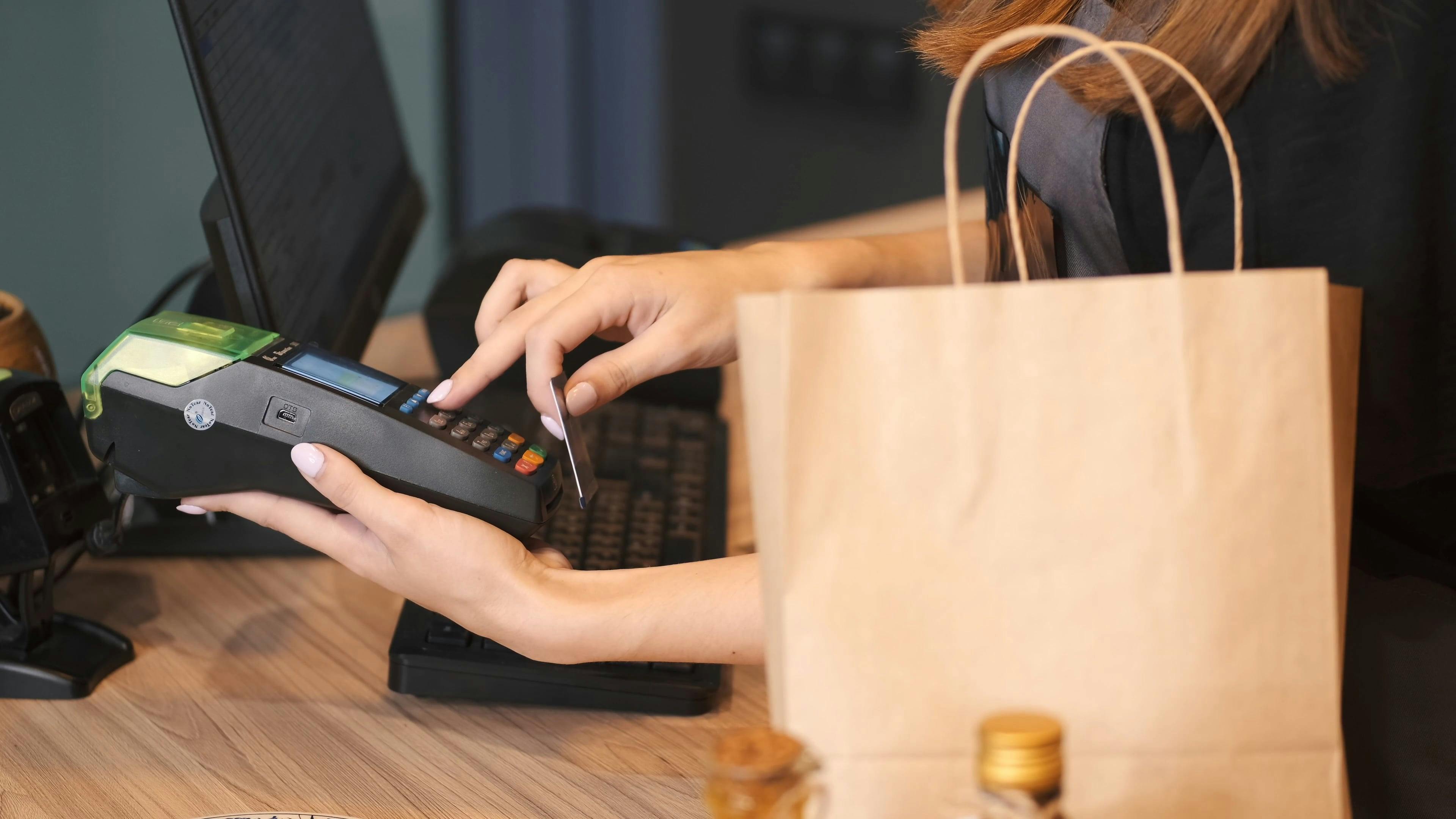 Woman Using Card Swipe Machine for Payment · Free Stock Video