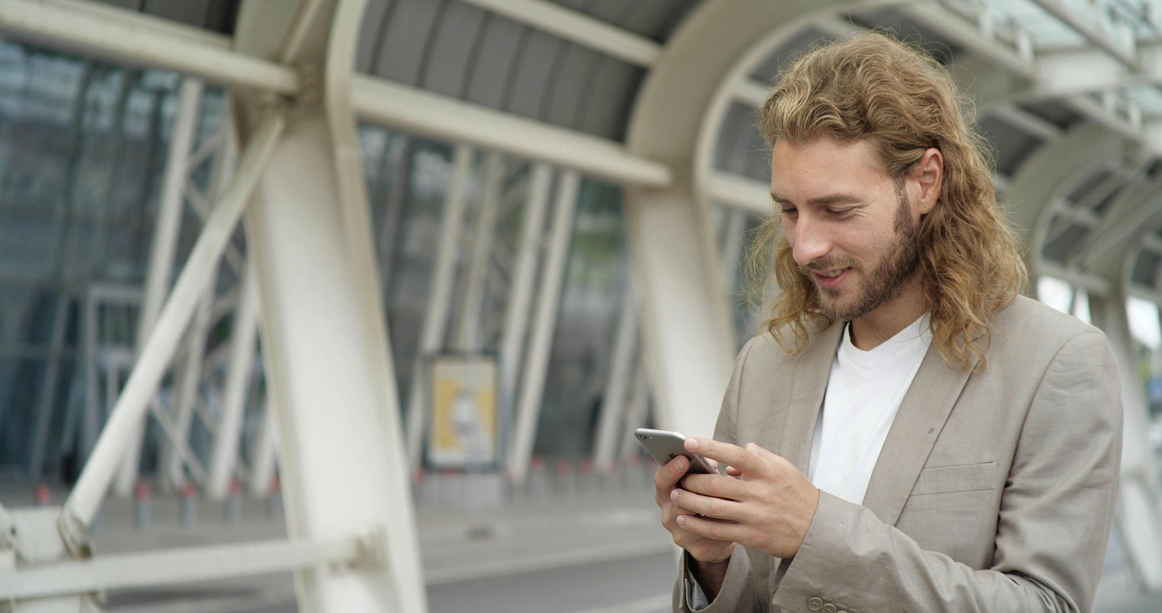 Long Haired French Guy Texting on his Mobile Phone Free Stock Video ...