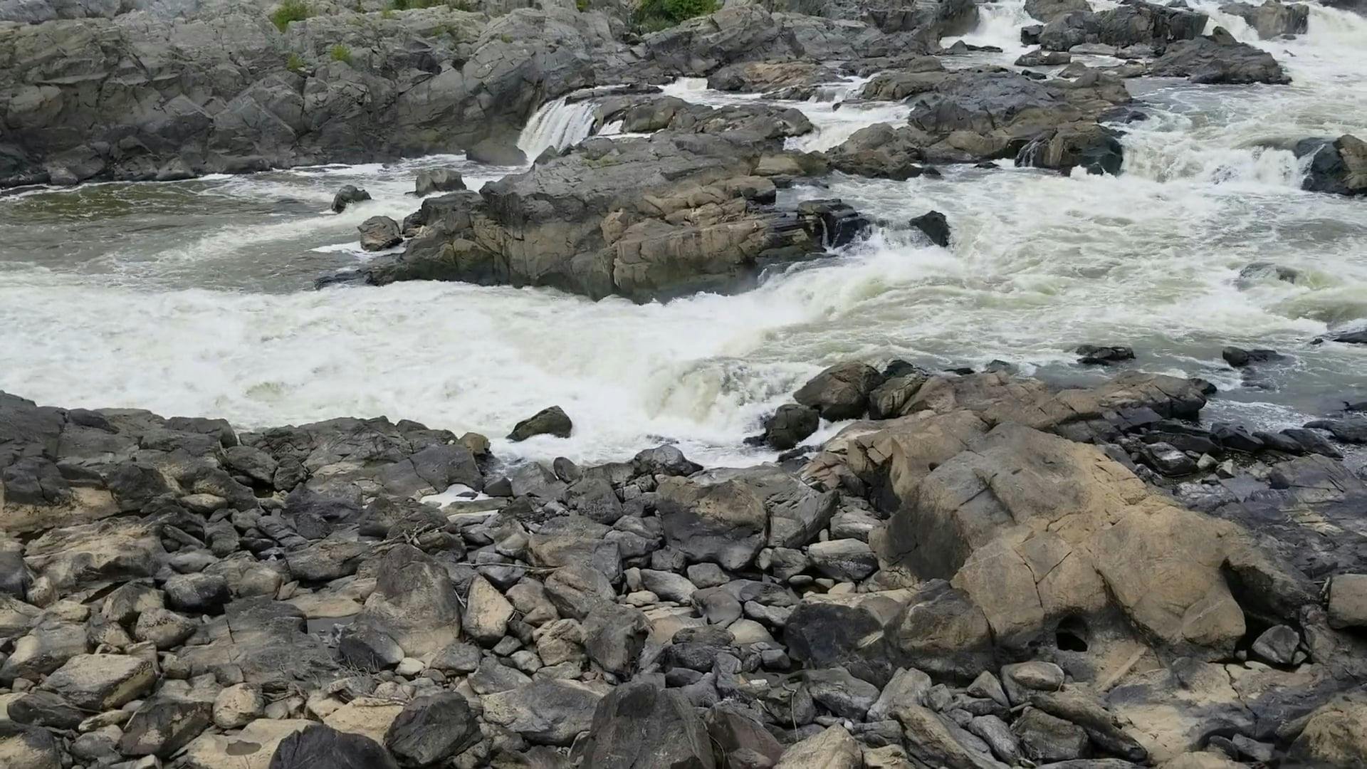 A River Flowing Through Rock Boulders · Free Stock Video