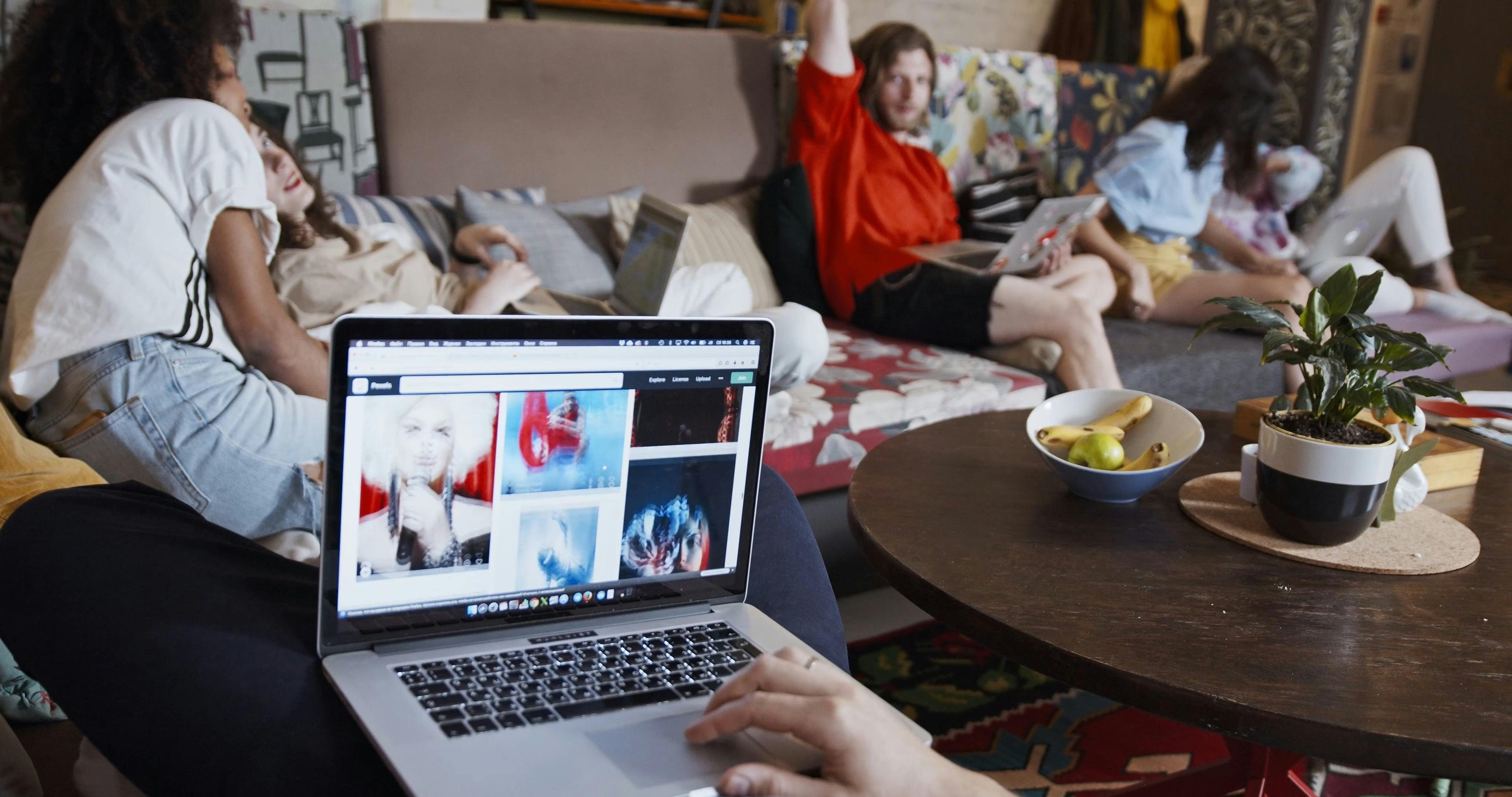 Person Browsing Internet While Friends are in Background Free Stock ...