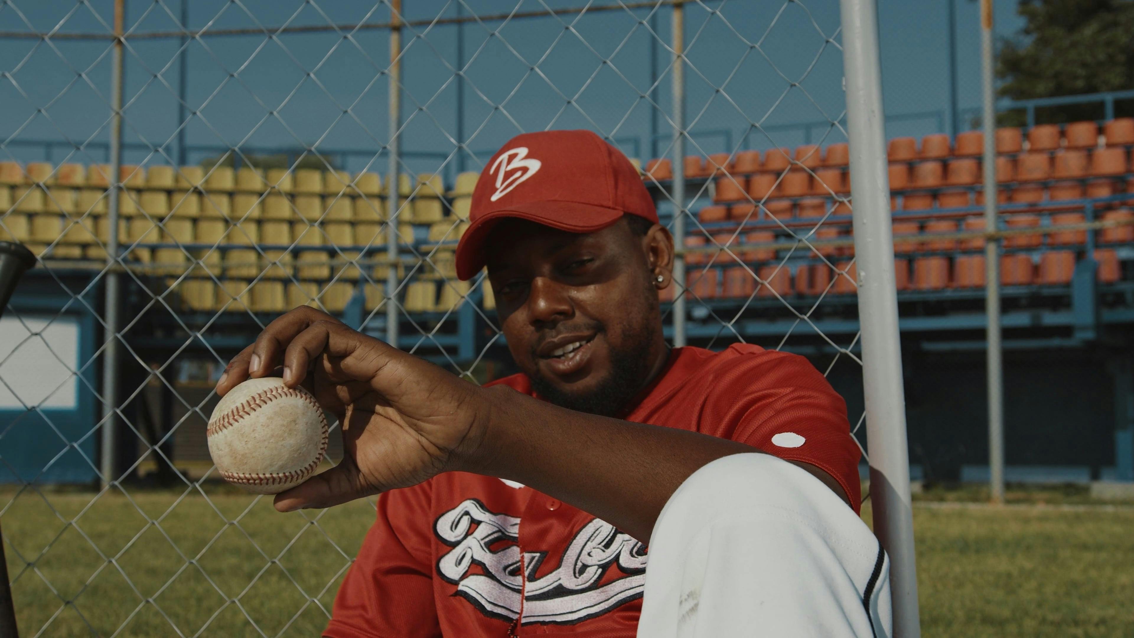 Baseball Player Looking Confident While Holding a Baseball Free Stock ...