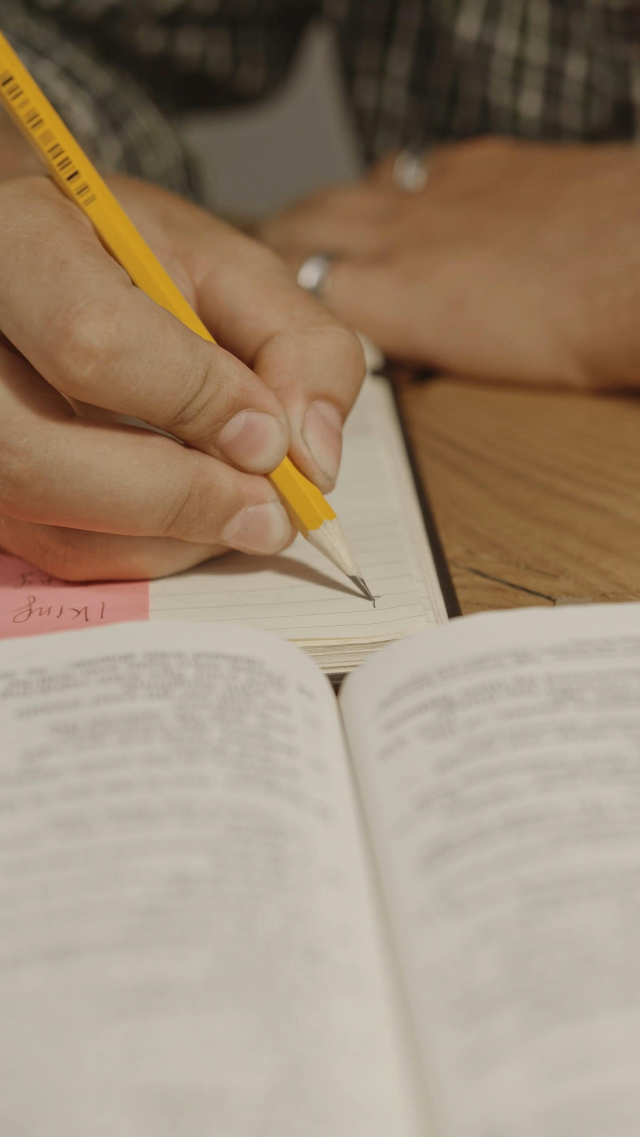 A Person Writing on the Notebook · Free Stock Video