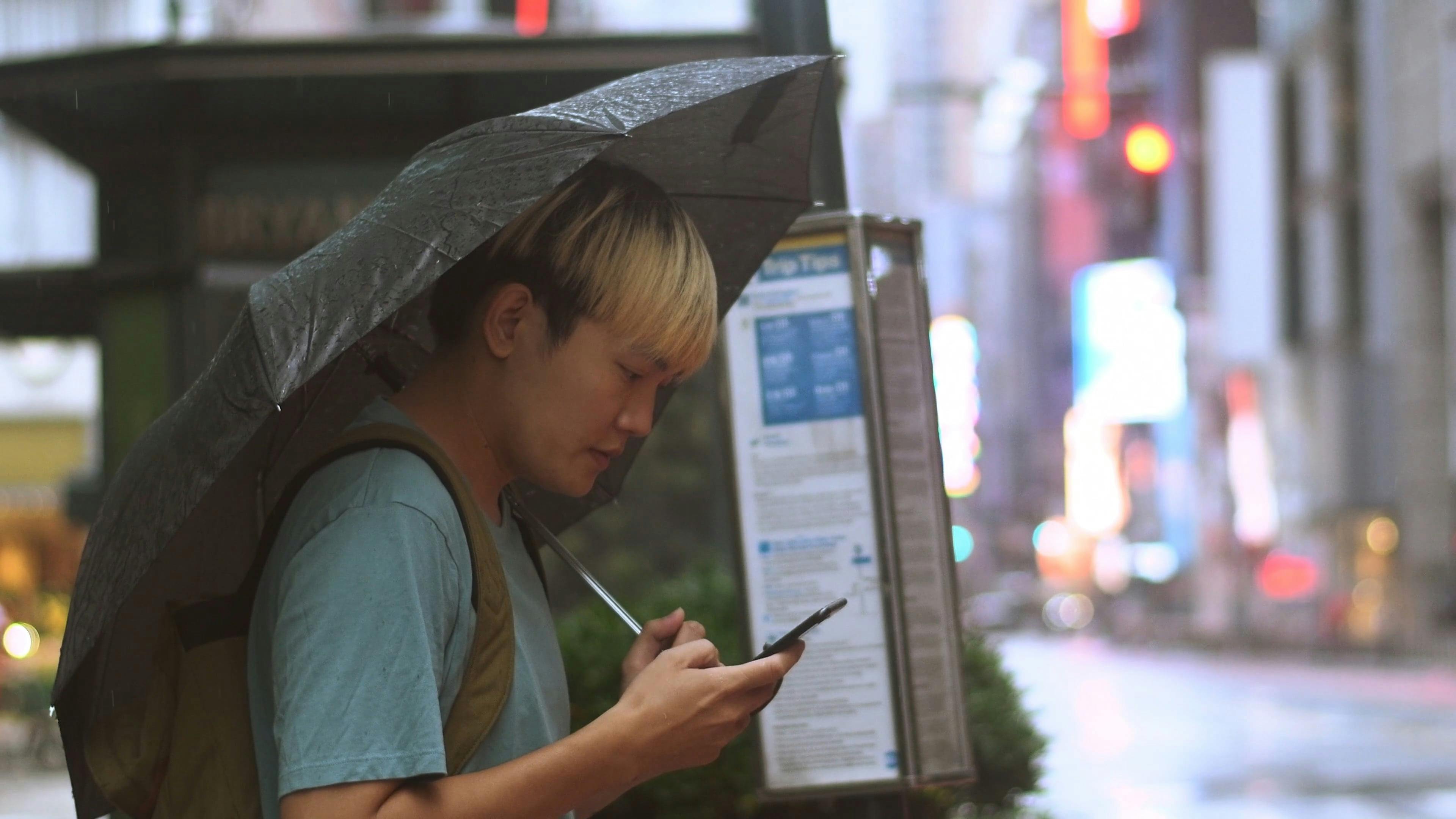 Man Talking on His Cellphone while Holding an Umbrella · Free Stock Video Man Talking on His Cellphone while Holding an Umbrella · Free Stock Video