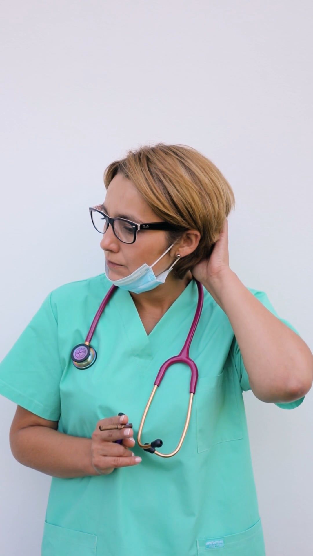 A Female Doctor Scratching her Head while Holding a Cigarette Free ...
