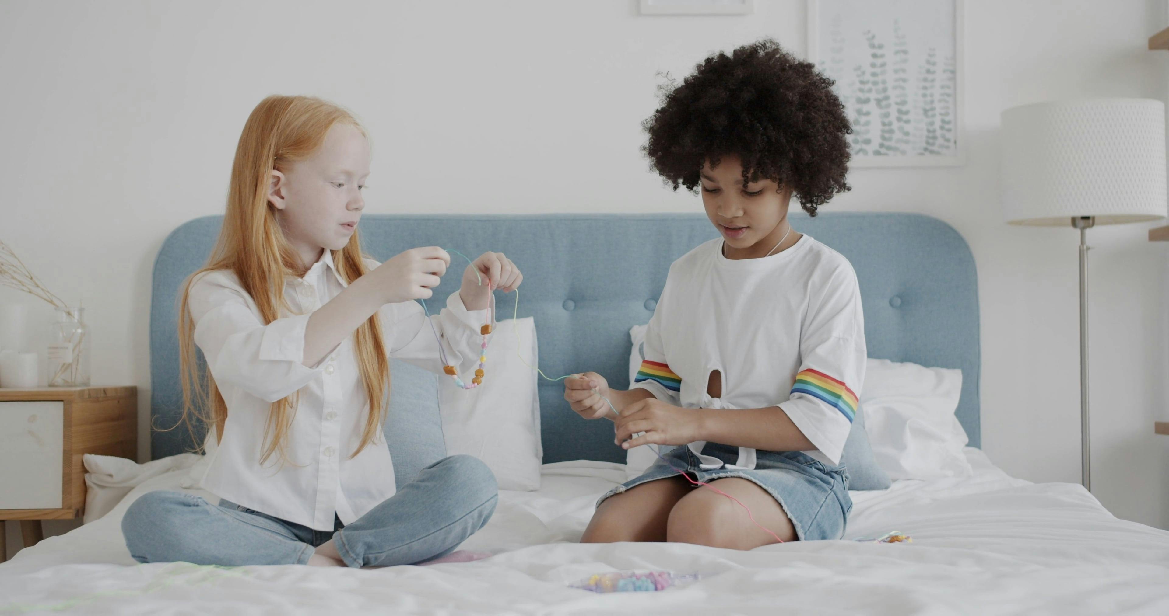 Two Girls Playing with Threads and Beads · Free Stock Video