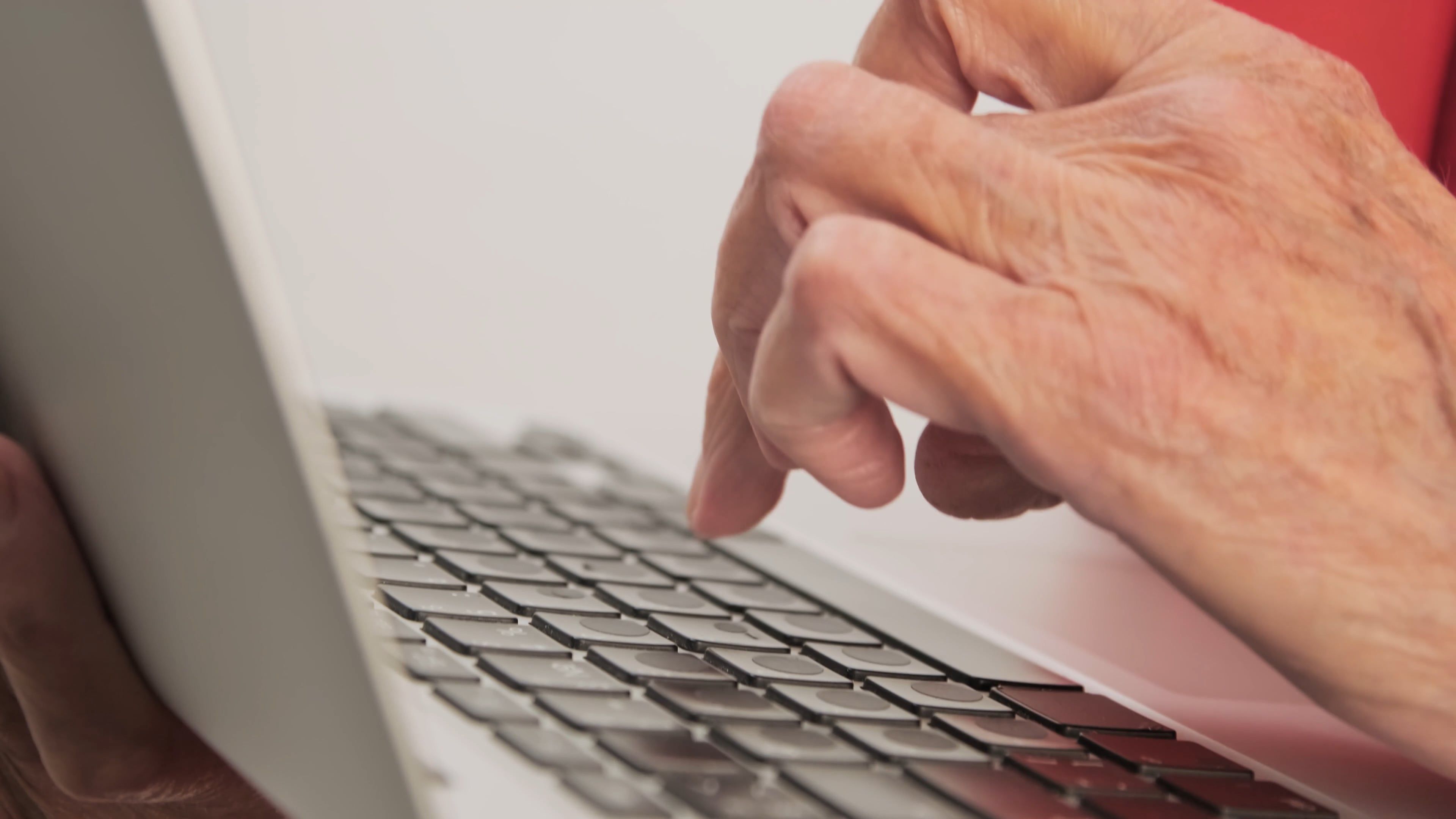 Elderly Person Typing on a Laptop · Free Stock Video