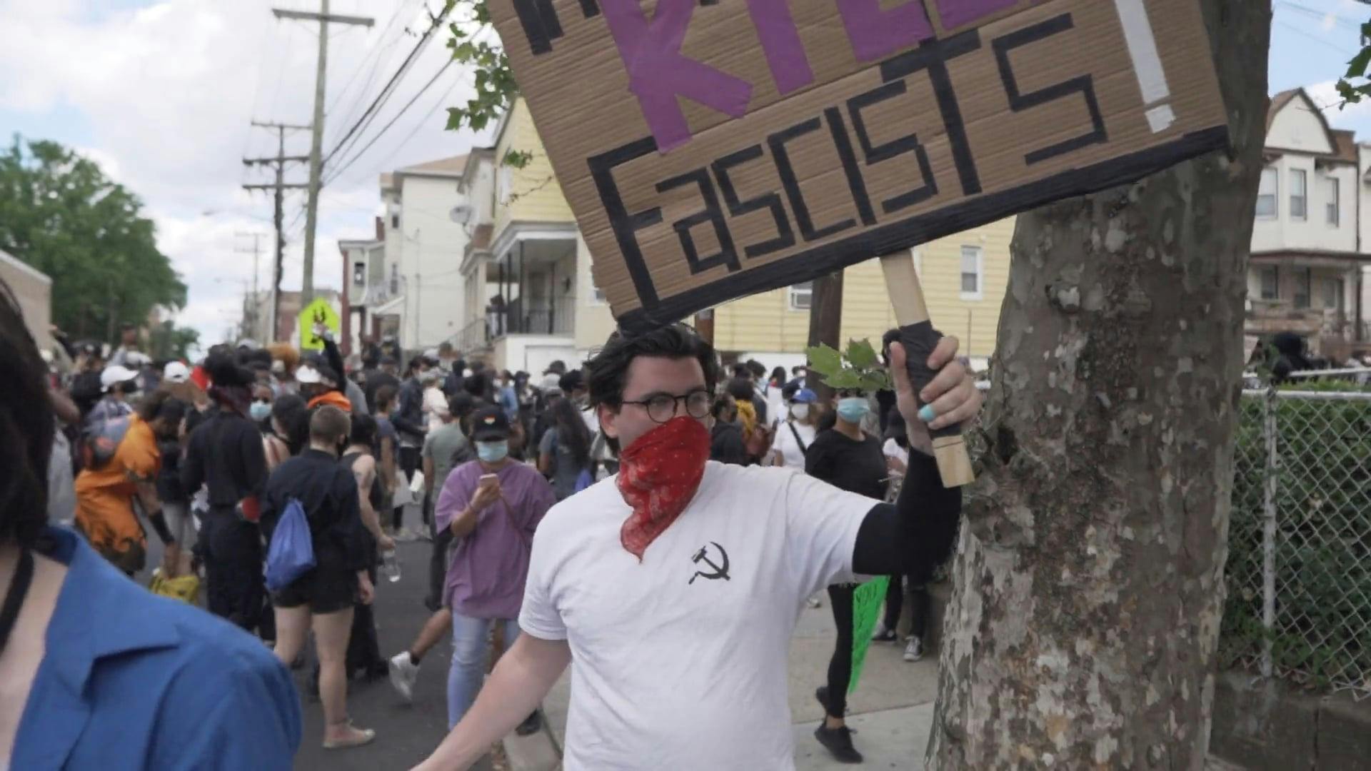 A Man Holding a Placard on a Street Rally · Free Stock Video