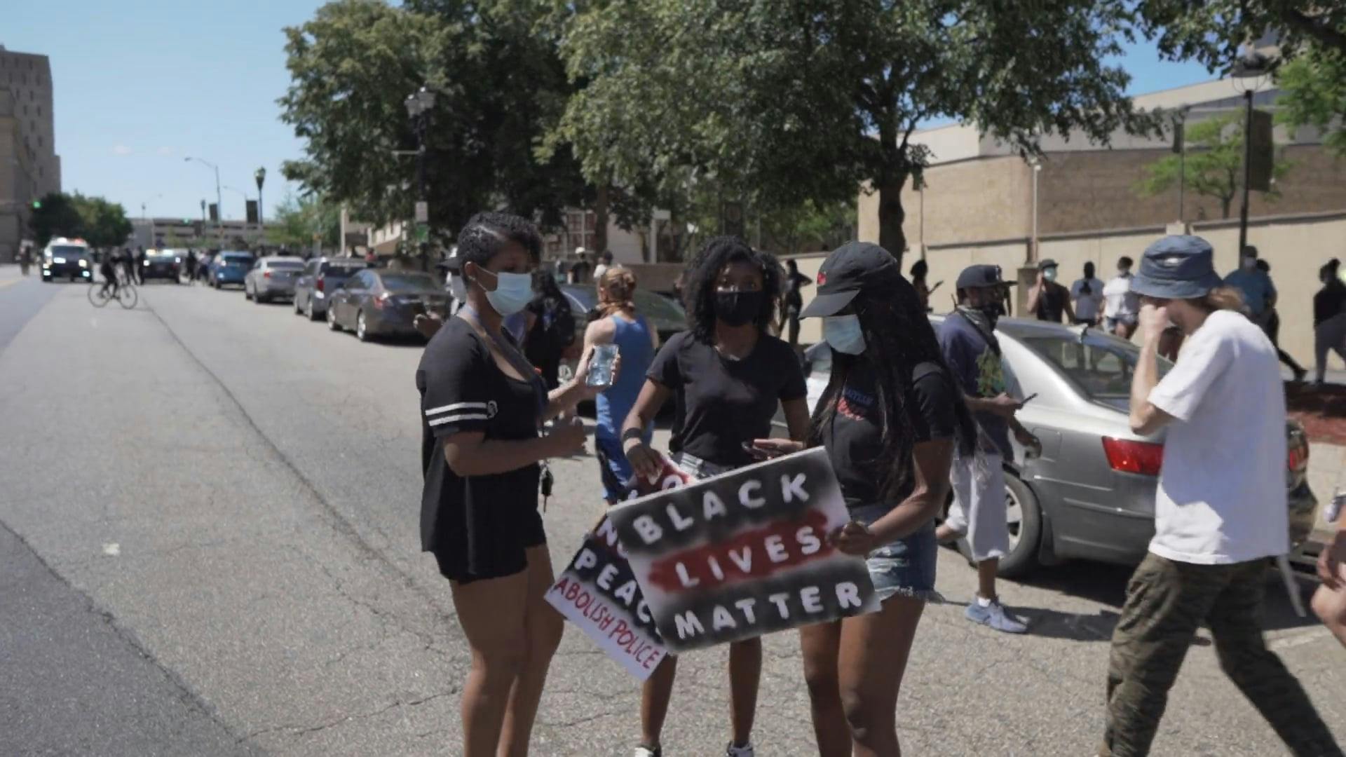 Women With Placards Standing While Raising Their Fists · Free Stock Video