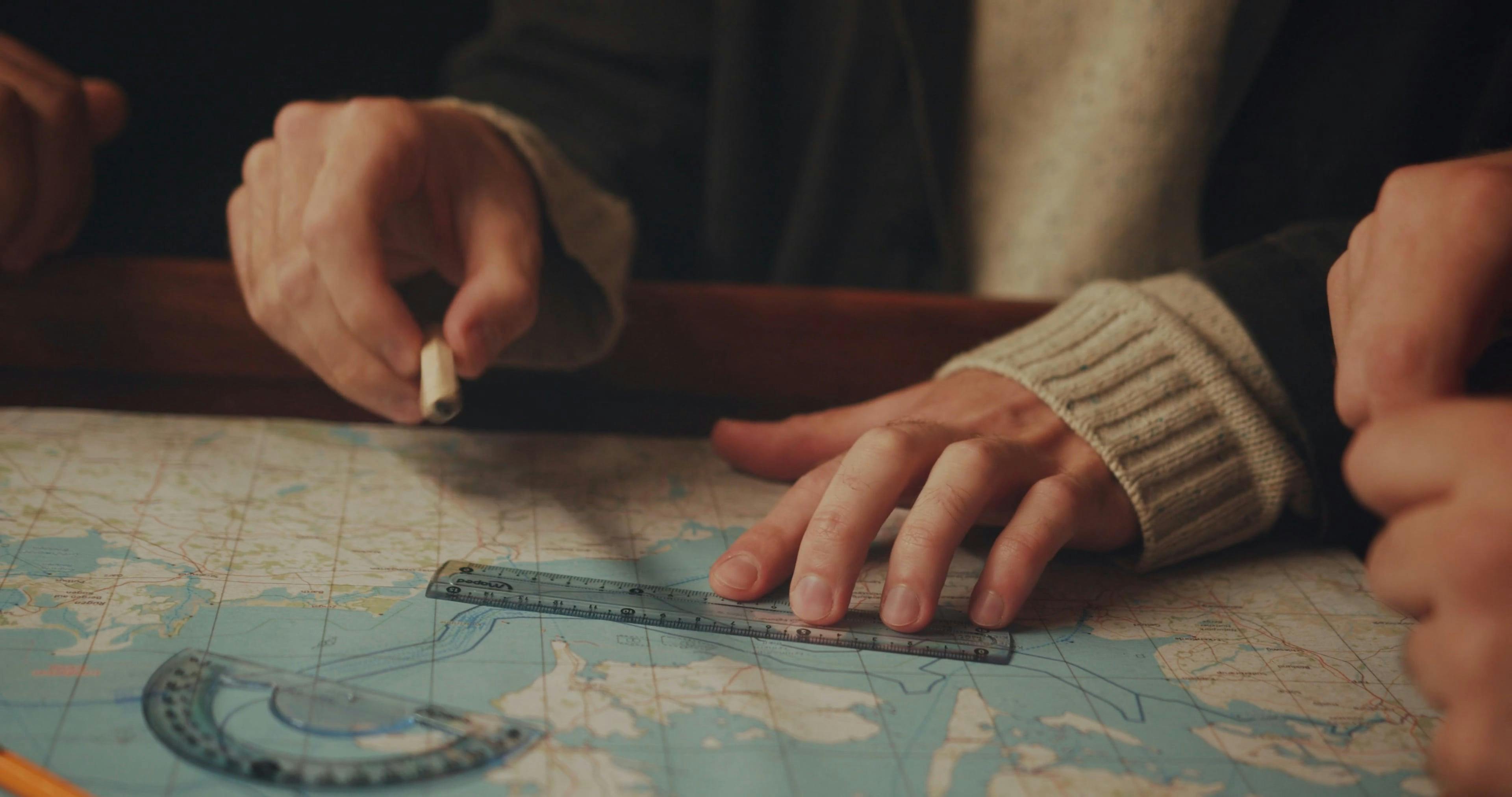 Man Drawing on a Map Using a Pencil and a Ruler · Free Stock Video