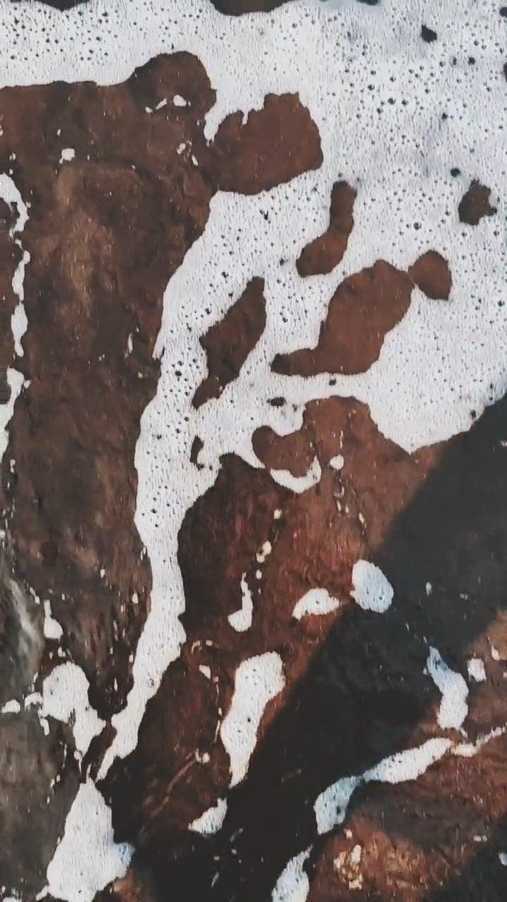 Video of Flowing Water on a Red Sand River · Free Stock Video