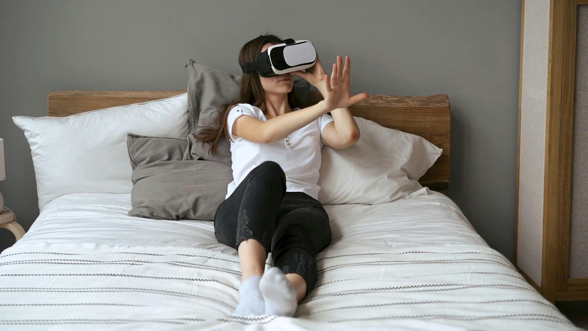 Woman Using a Virtual Reality Box on the Bed · Free Stock Video