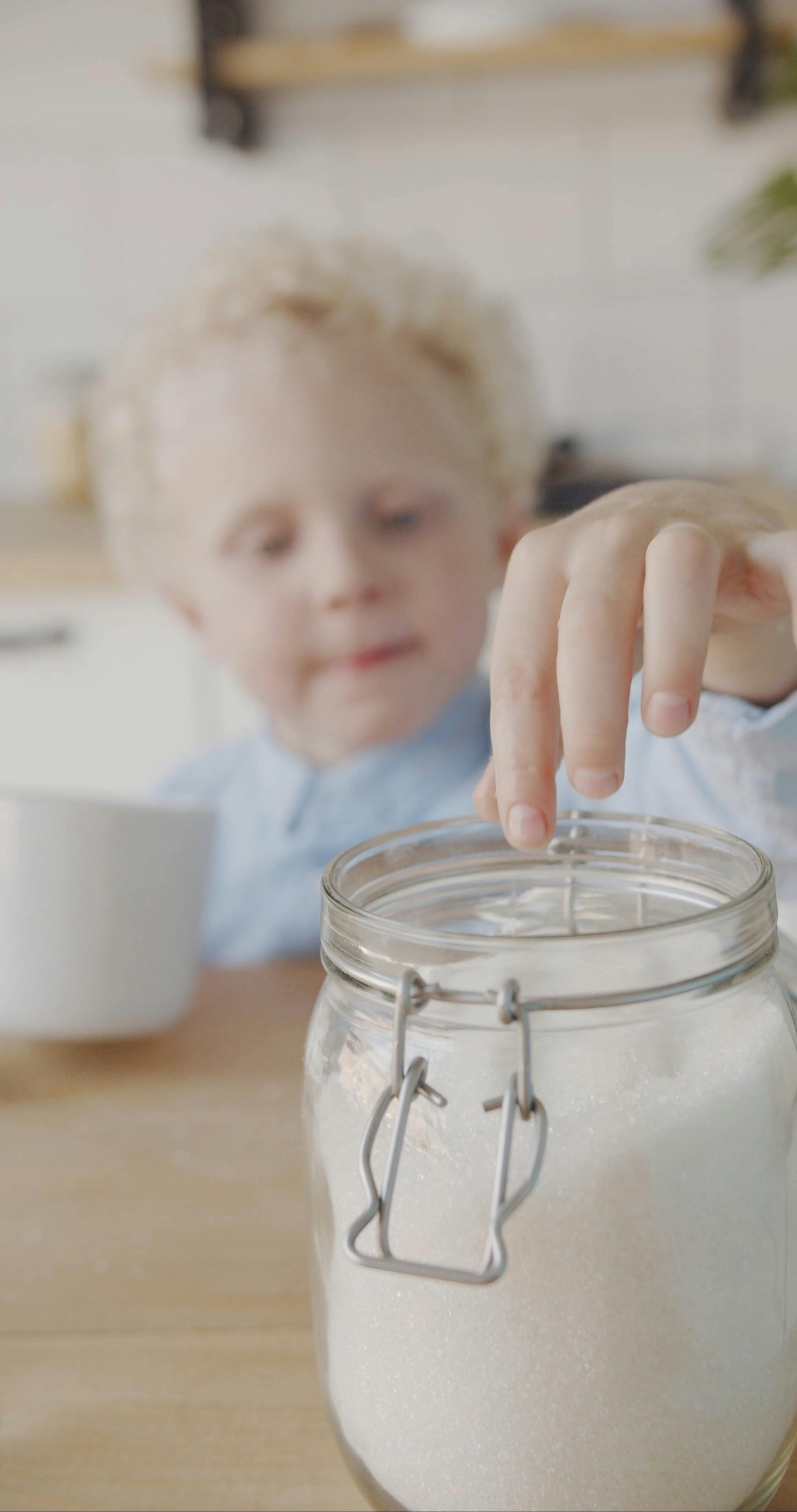 Boy Eating Powdered Sugar from a Jar · Free Stock Video