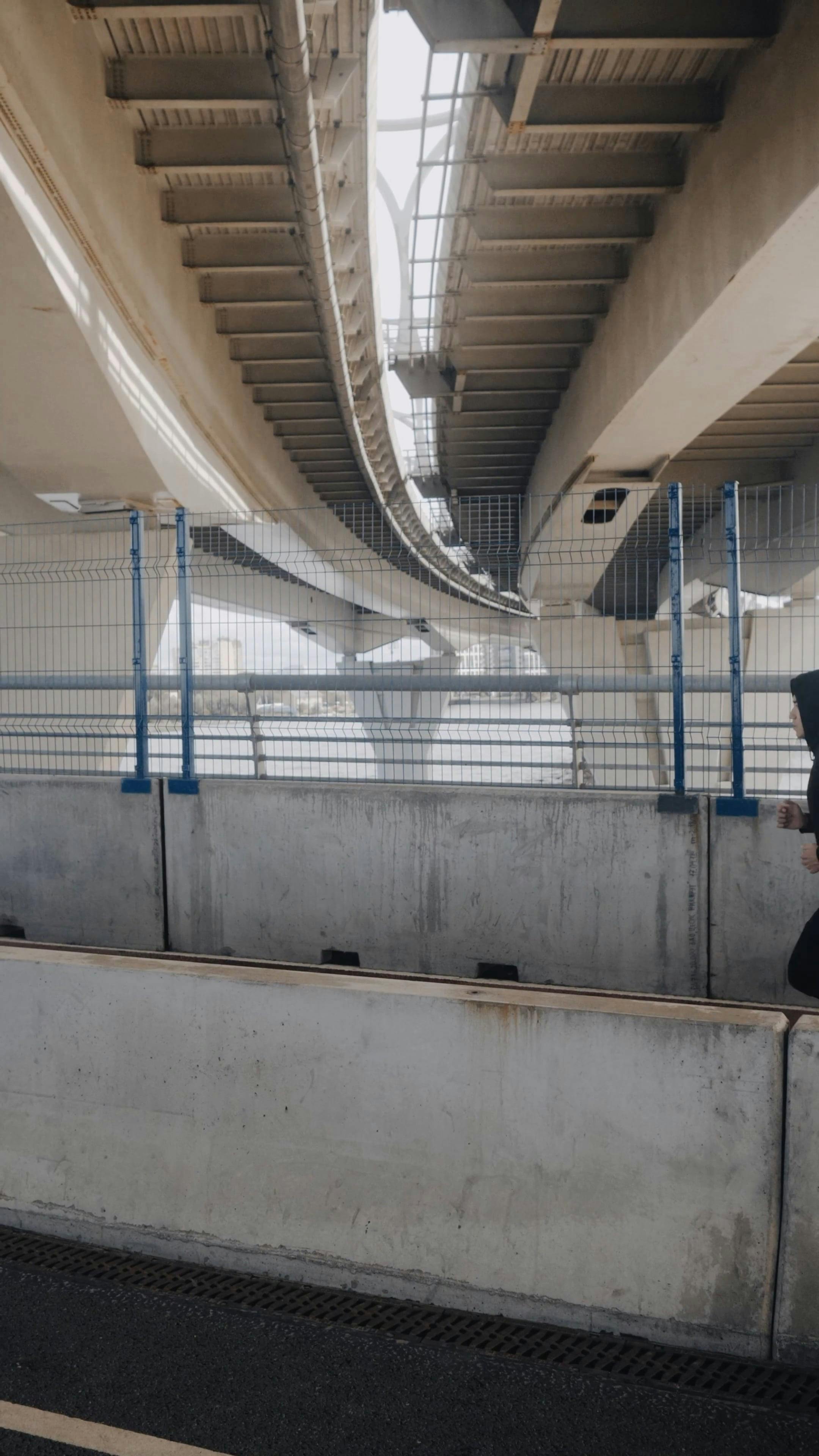 Friends Jogging Together on a Sidewalk Under the Bridge · Free Stock Video