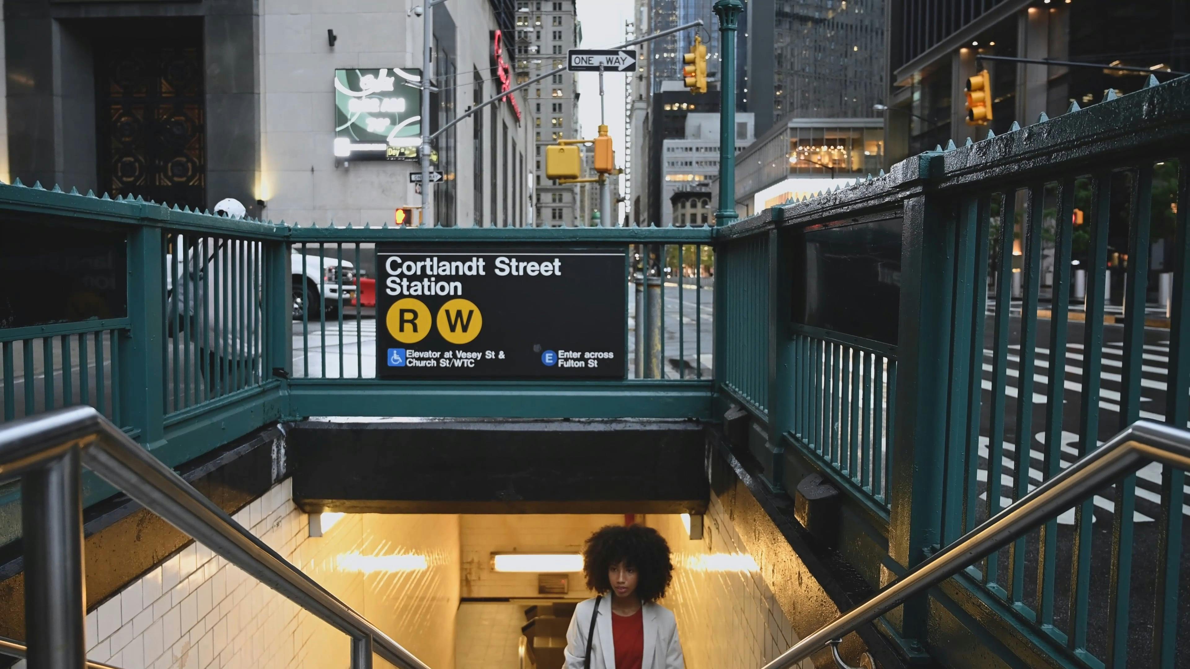 Young Woman Walking Up the Subway Steps While Opening Her Umbrella Free ...