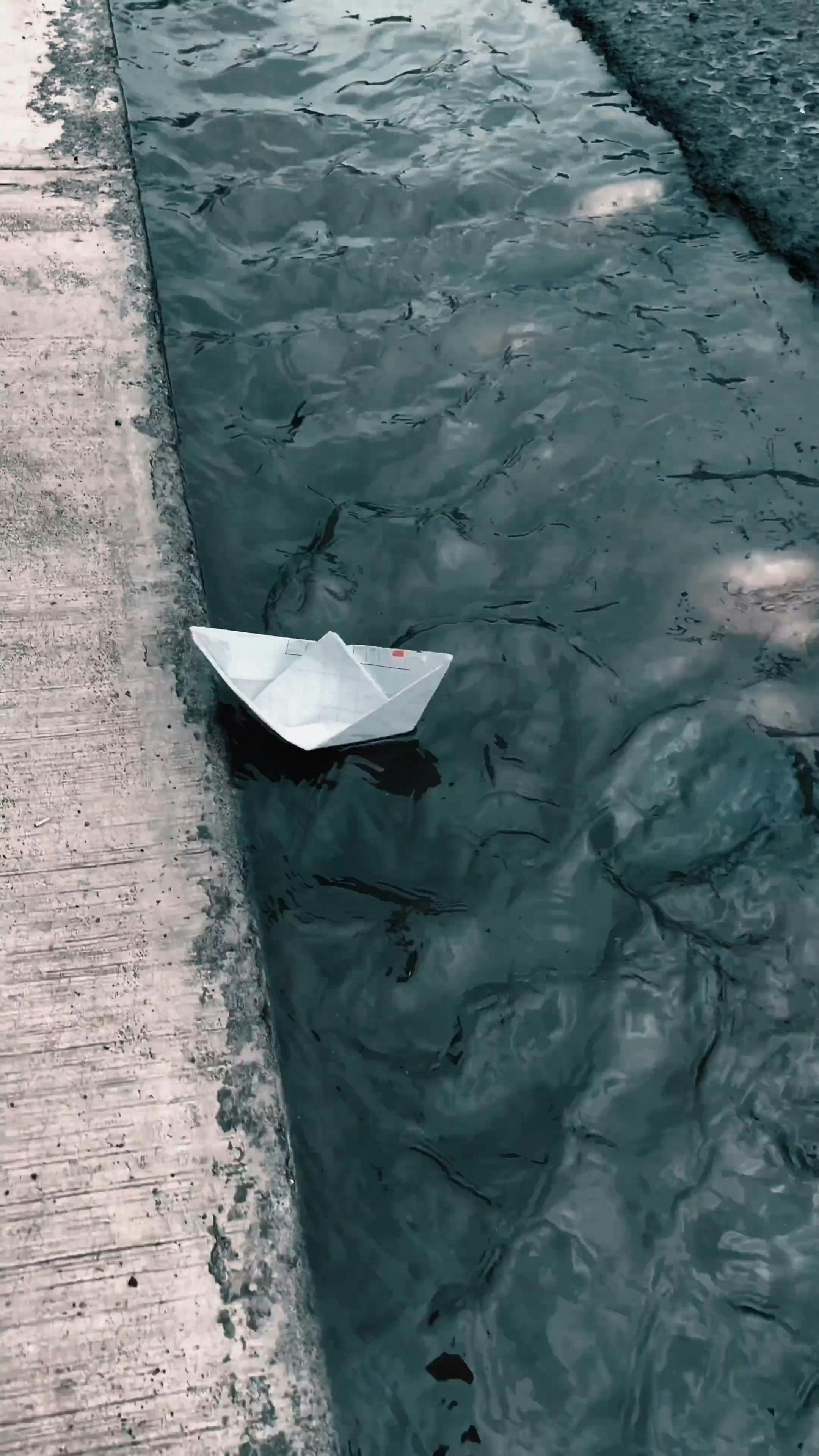 A Paper Boat Floating Over A Roadside Water Canal · Free Stock Video
