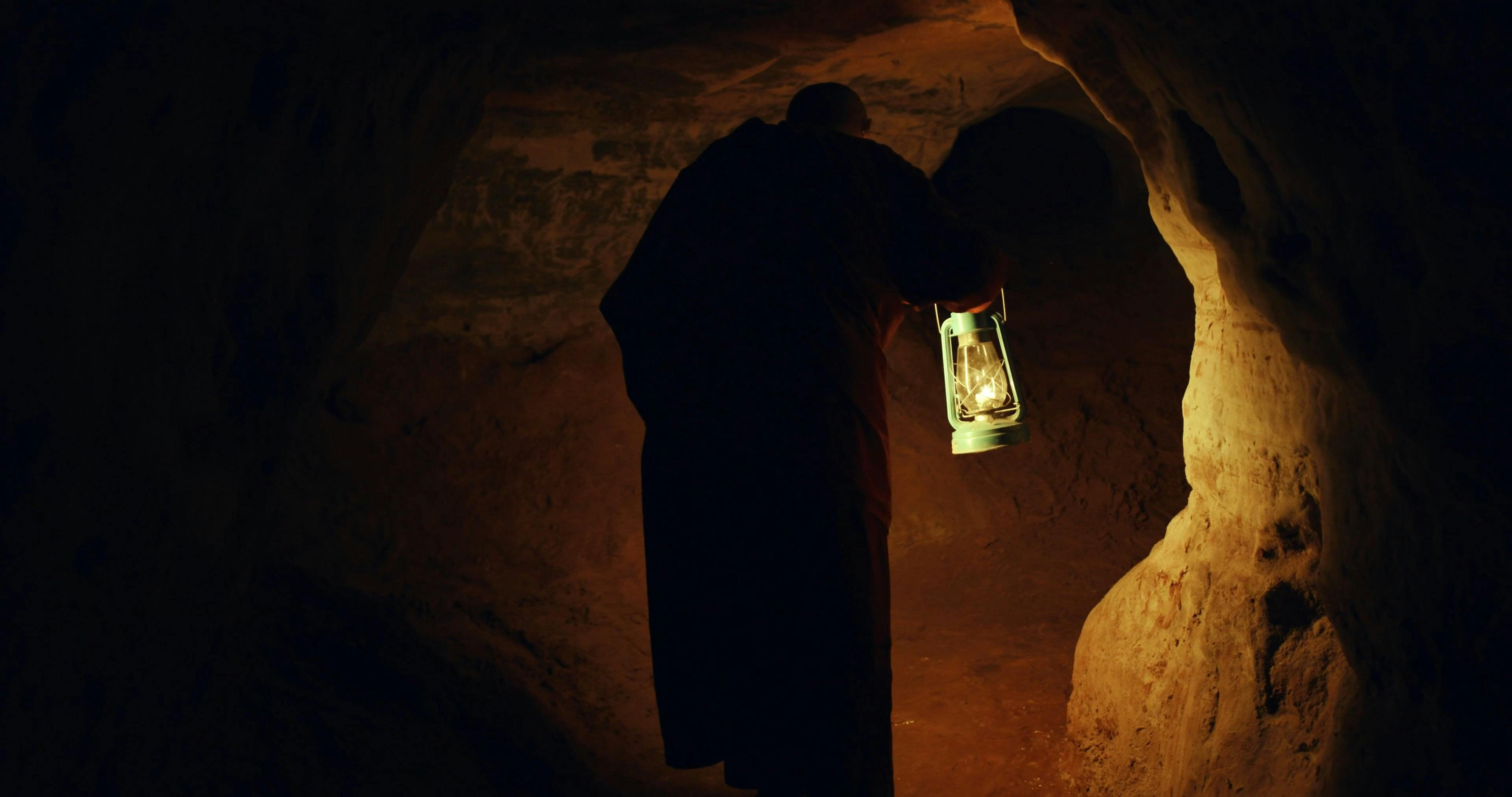 A Person Holding a Lantern Inside a Dark Tunnel · Free Stock Video
