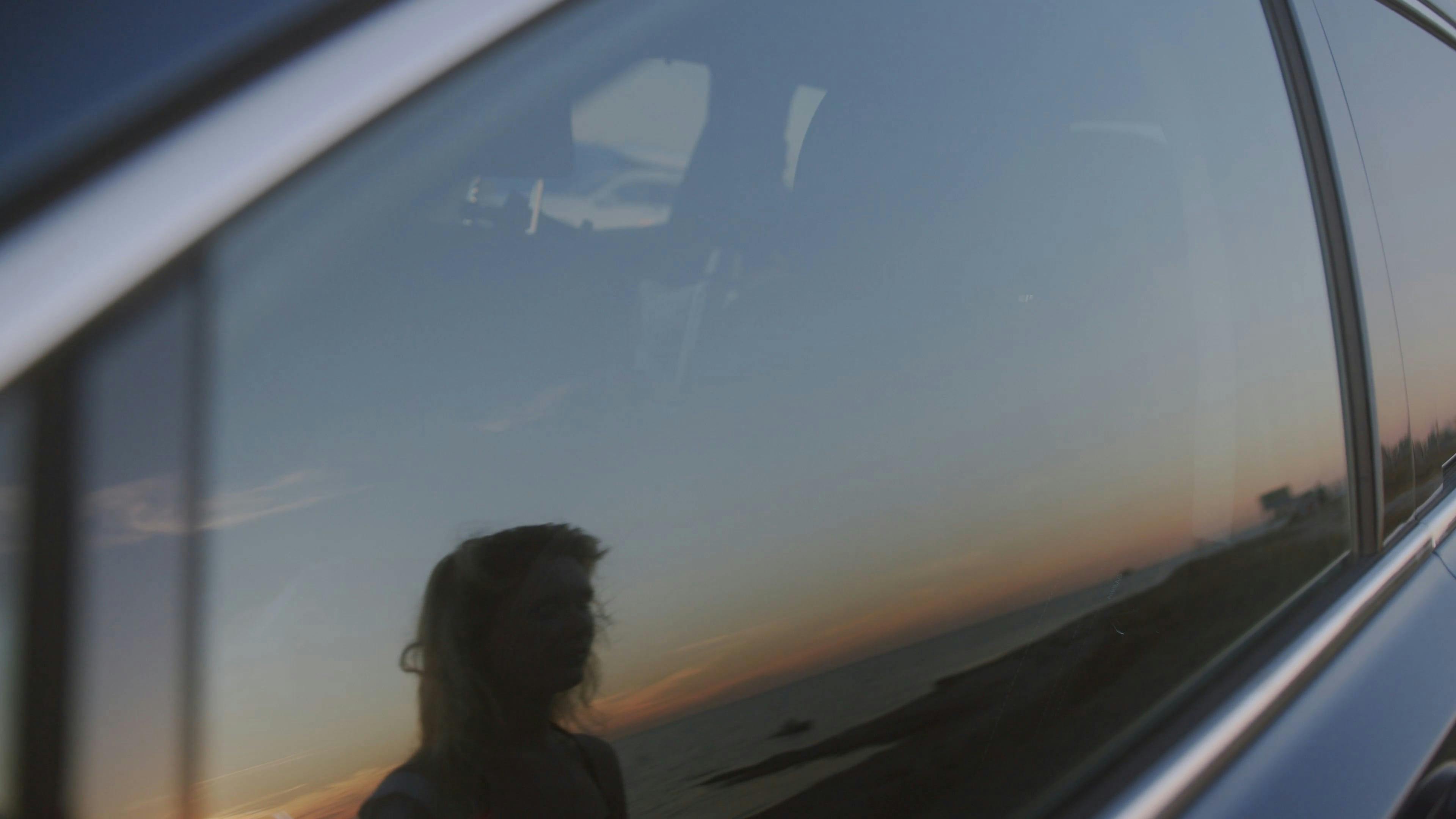 Young Woman Reflection on Car window · Free Stock Video