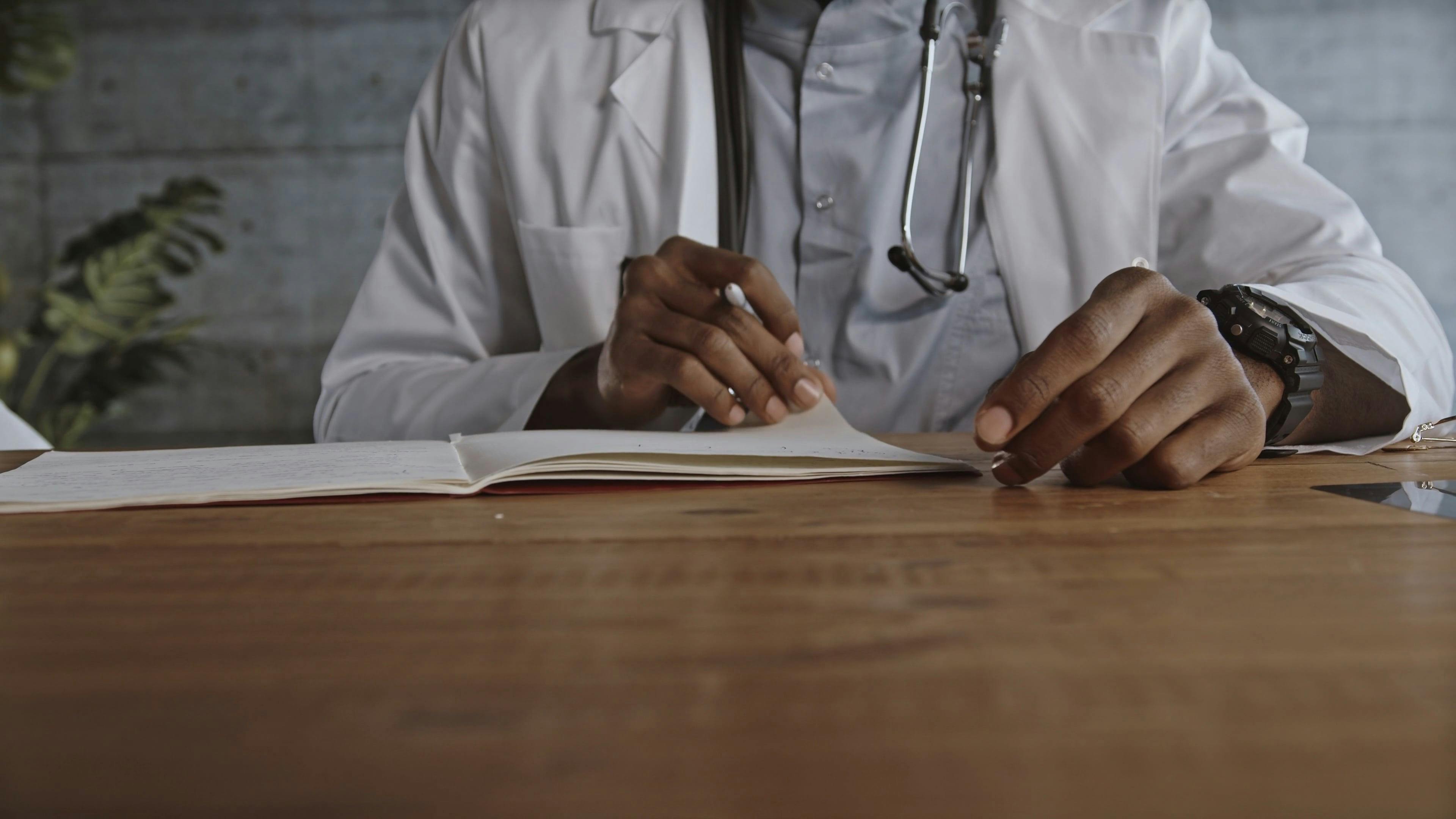 Doctor Writing on Paper · Free Stock Video