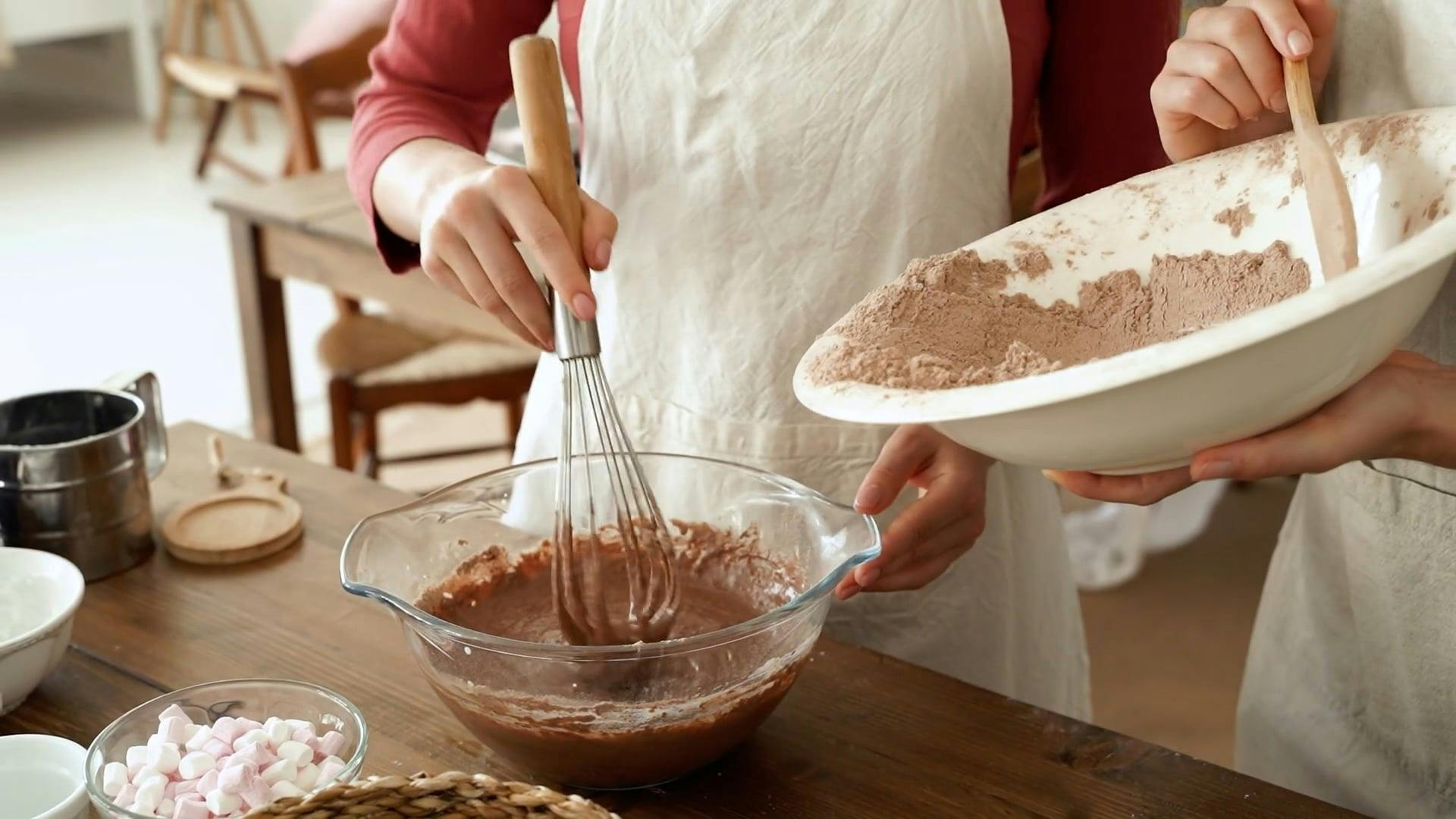 Two Women Preparing A Chocolate Batter For Baking Free Stock Video ...