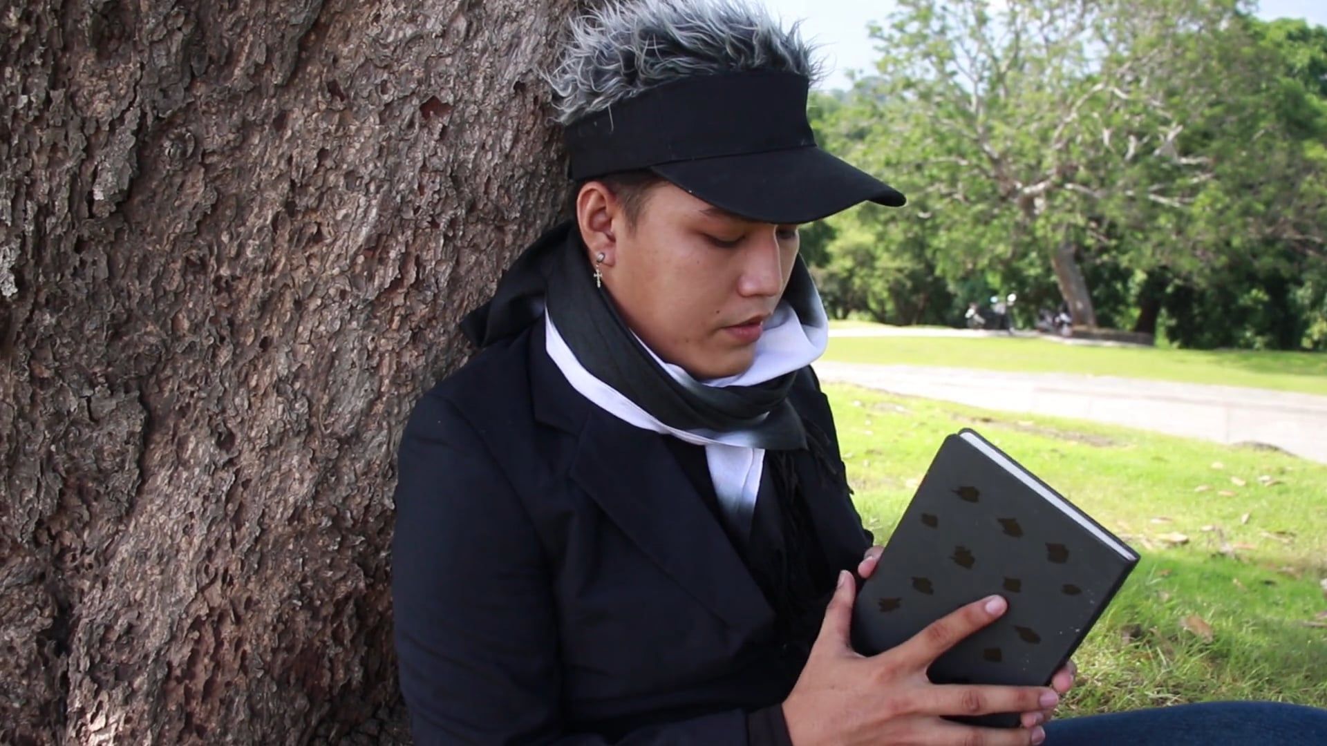 Young Man Sitting Under Tree Reading Free Stock Video Footage, Royalty ...