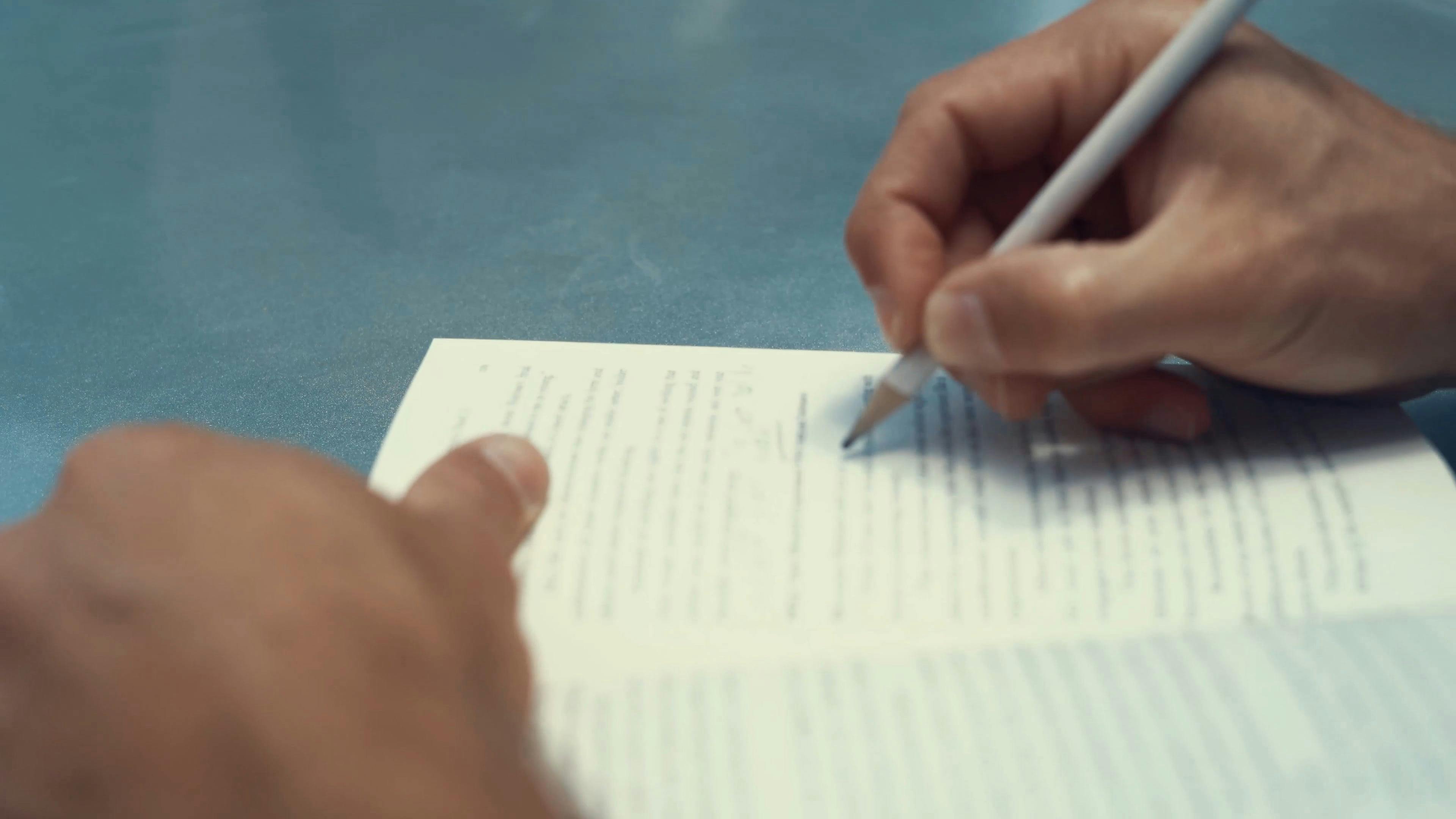 Writing And Erasing On A Sheet Of Paper · Free Stock Video
