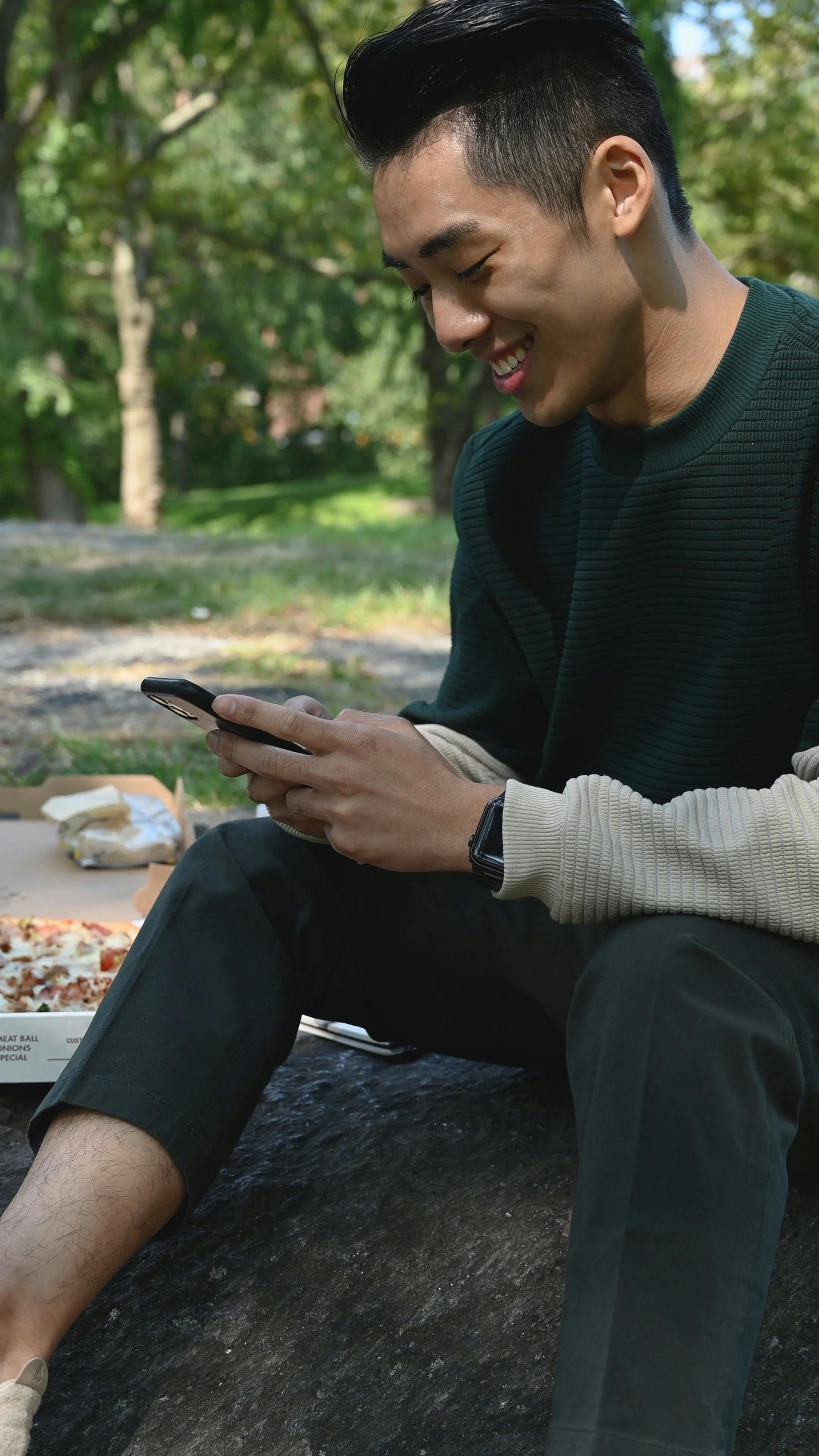 Young Man Text Messaging During Lunch Break in Park · Free Stock Video