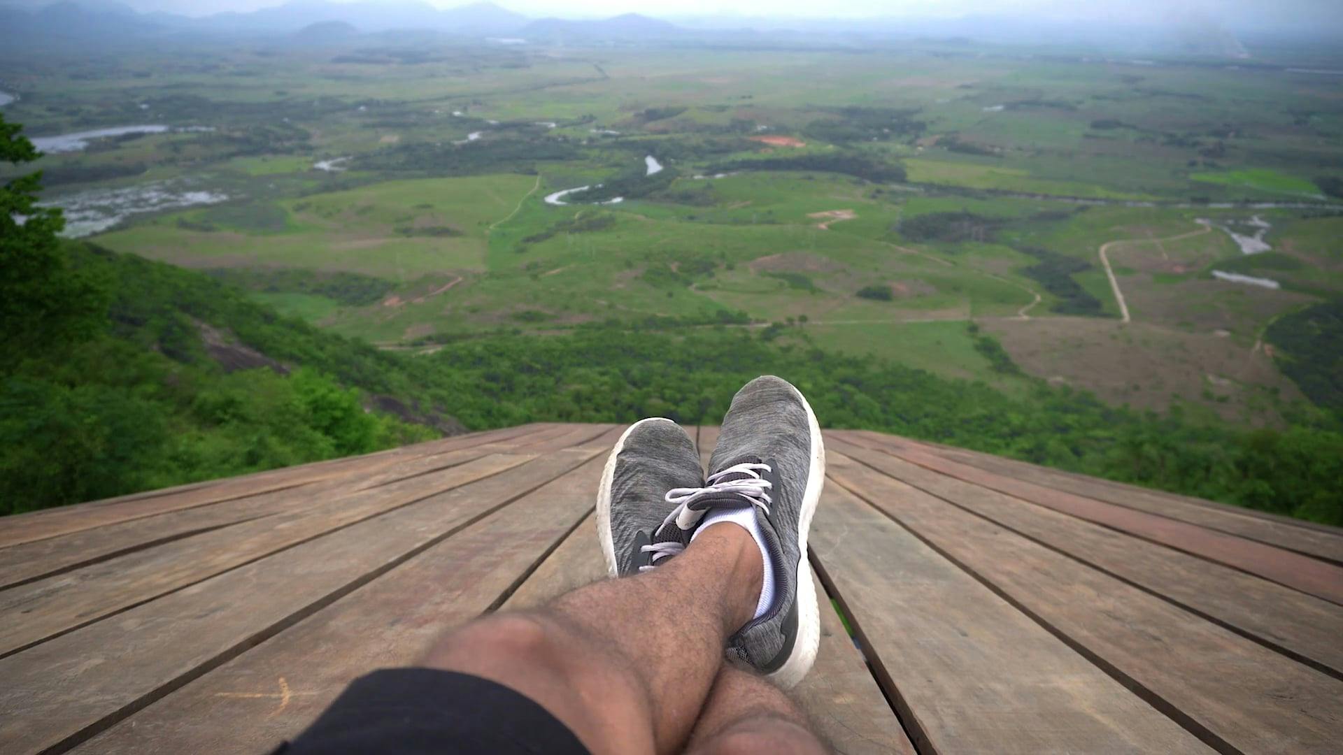Person Sitting on a Wooden Platform at the Top of a Mountain · Free ...