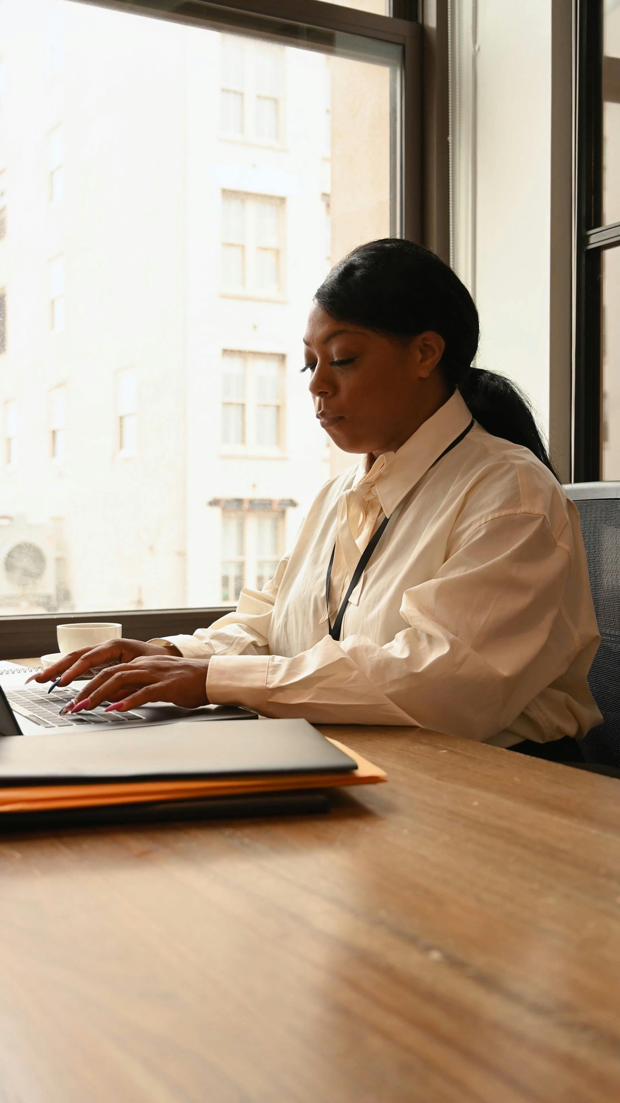 Woman at Desk Typing on Laptop · Free Stock Video