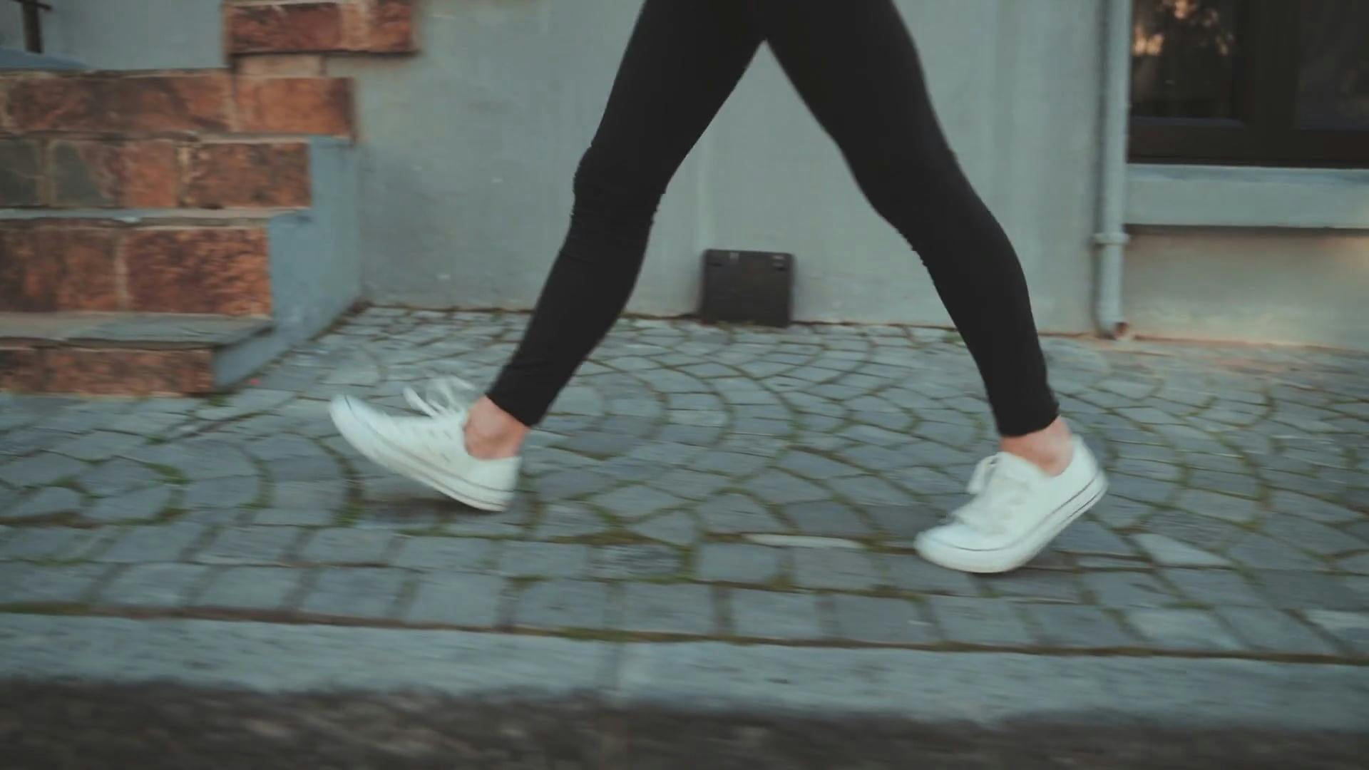 A Person Walking on a Sidewalk · Free Stock Video