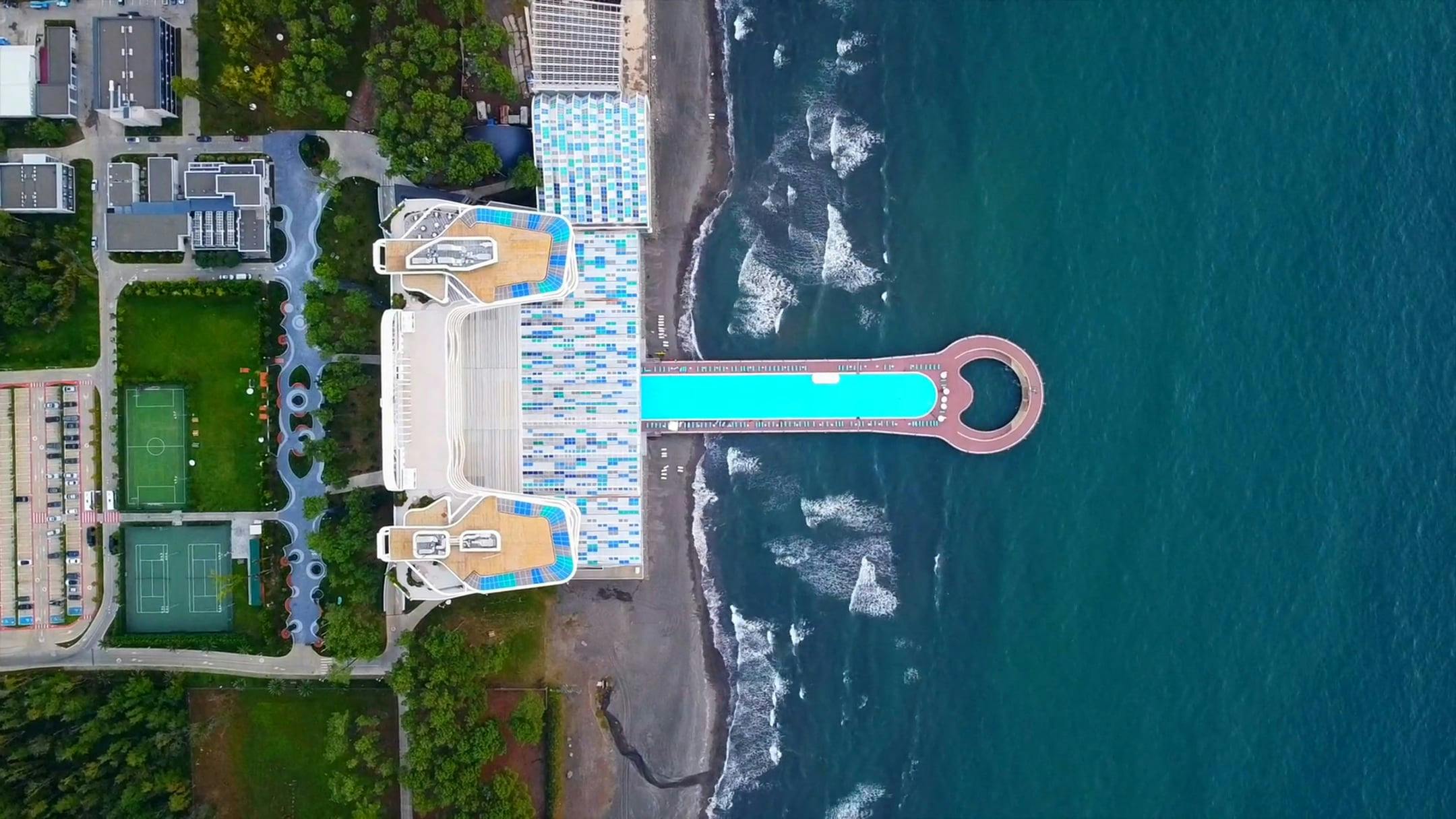 Drone Footage of a Long Swimming Pool on the Seashore · Free Stock Video