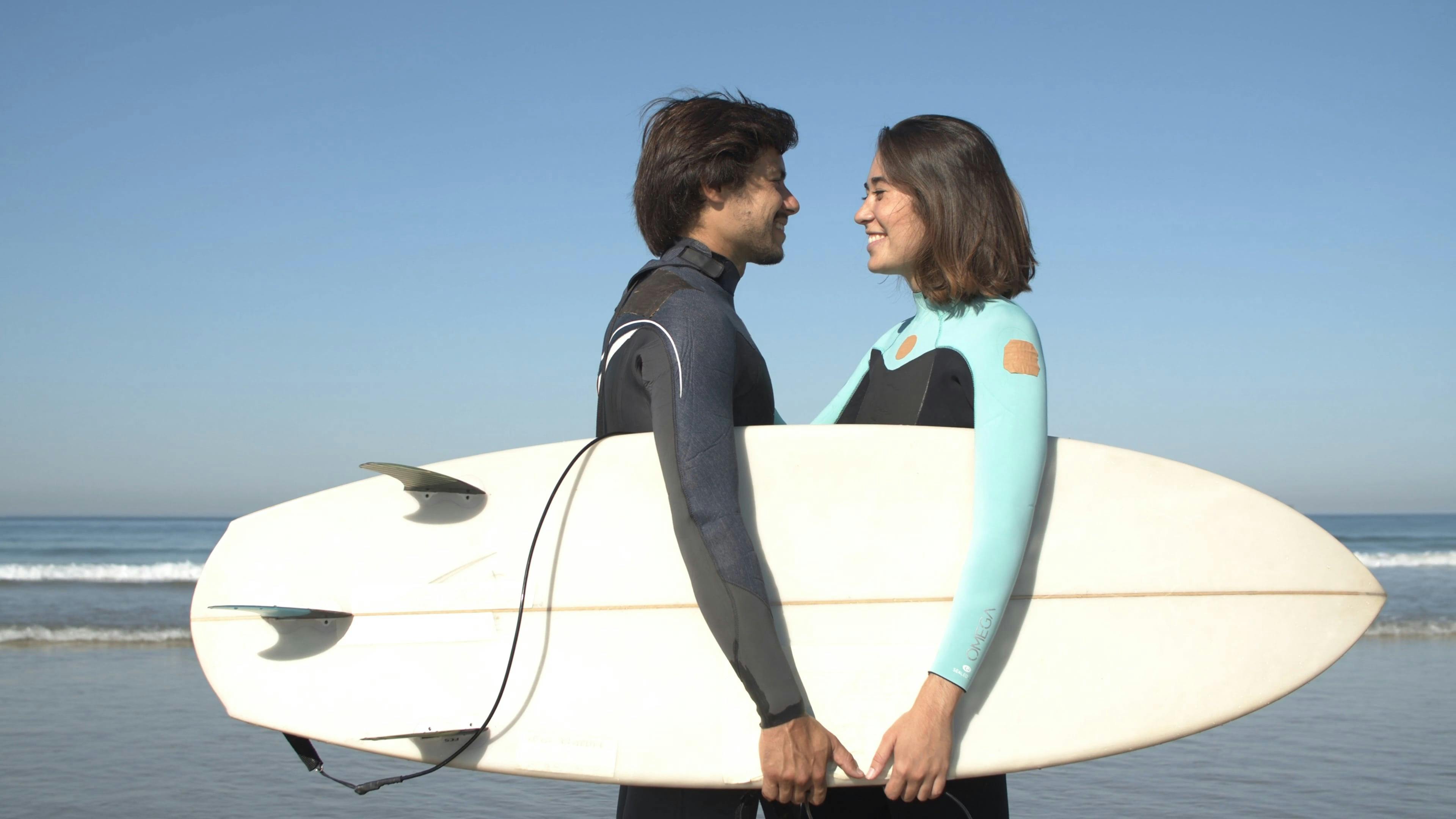 Couple Holding A Surfboard Kissing · Free Stock Video