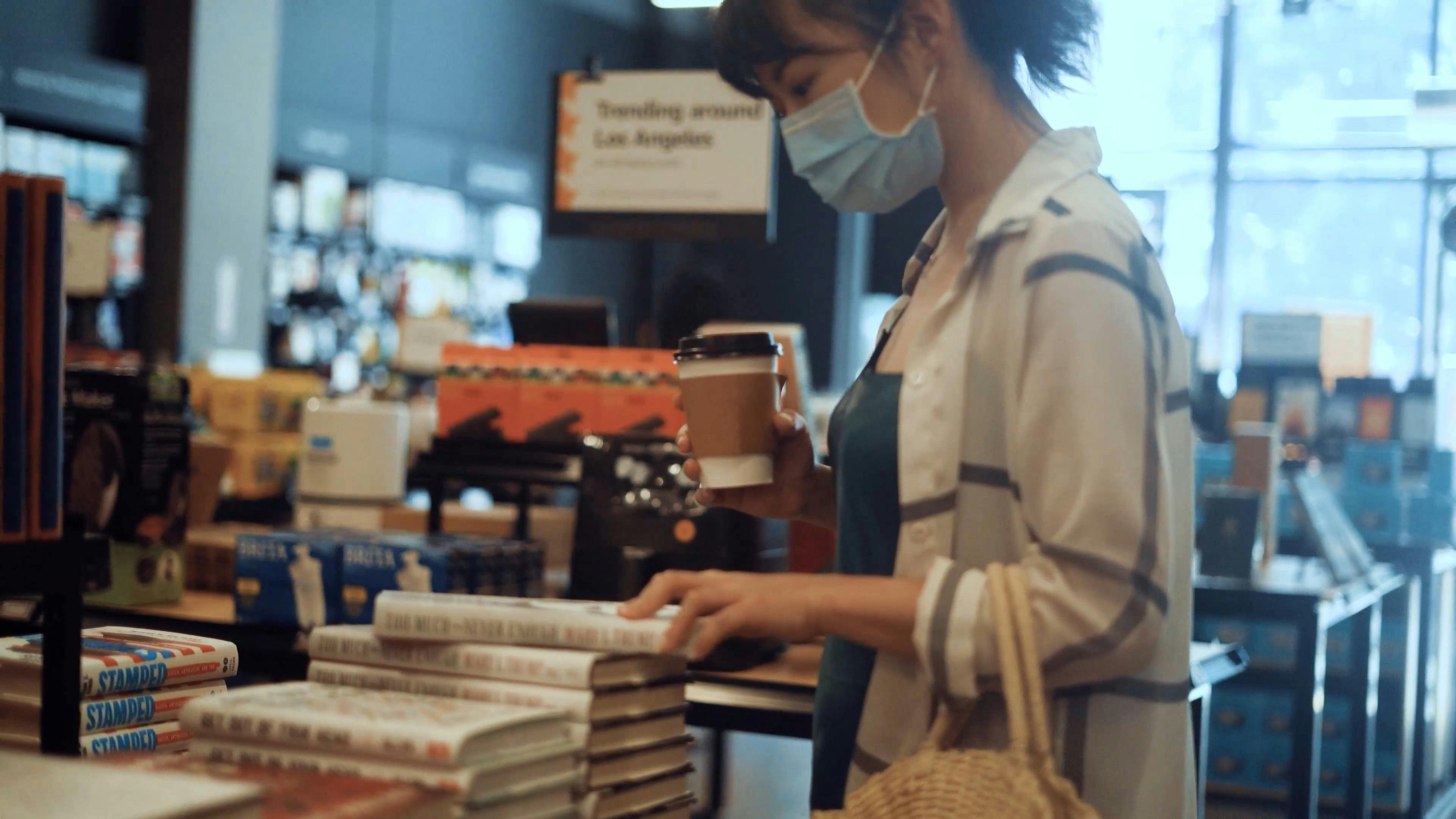 Girl Checking Out Books in a Bookshop · Free Stock Video