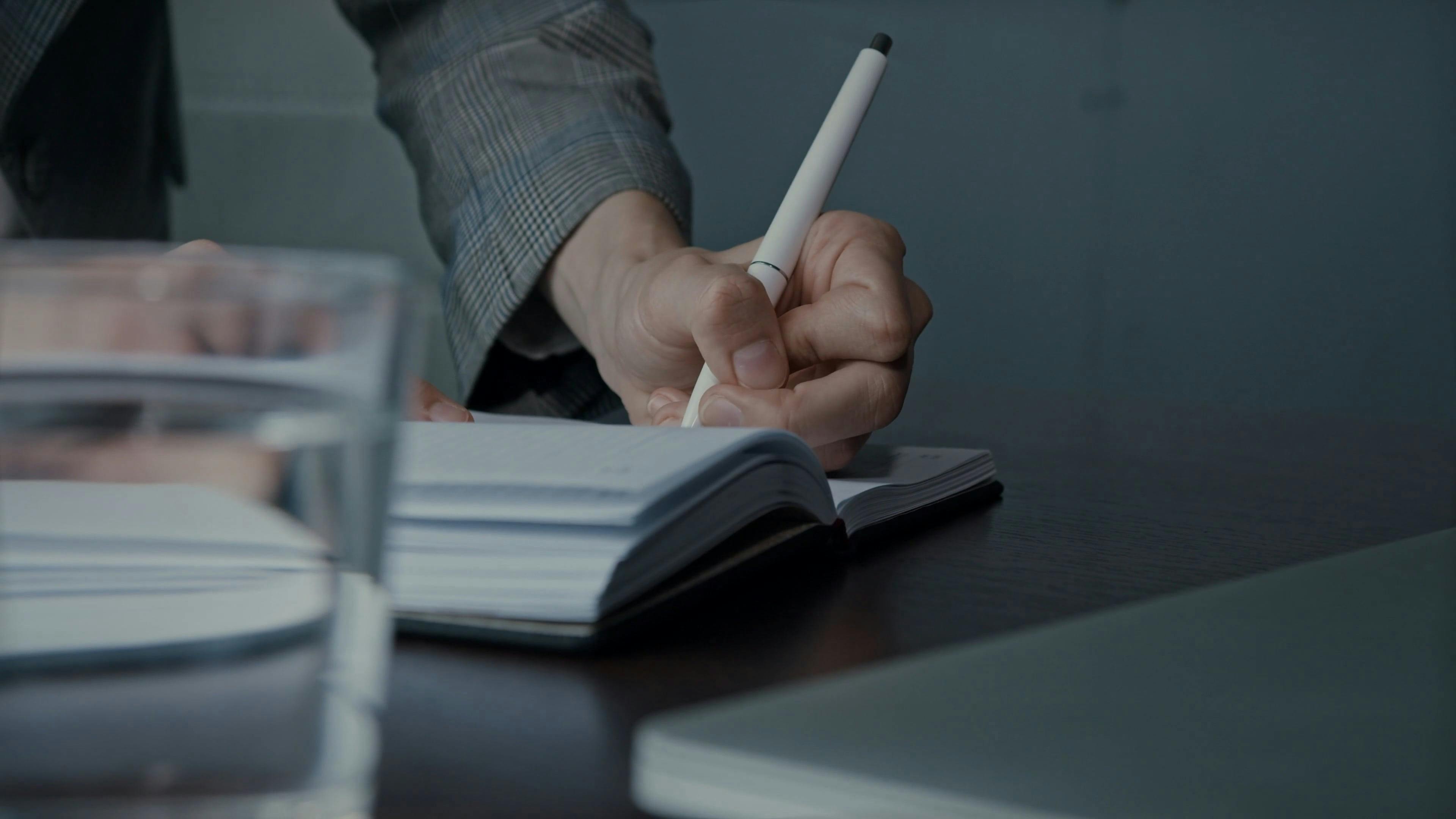 Person Writing on Notebook · Free Stock Video