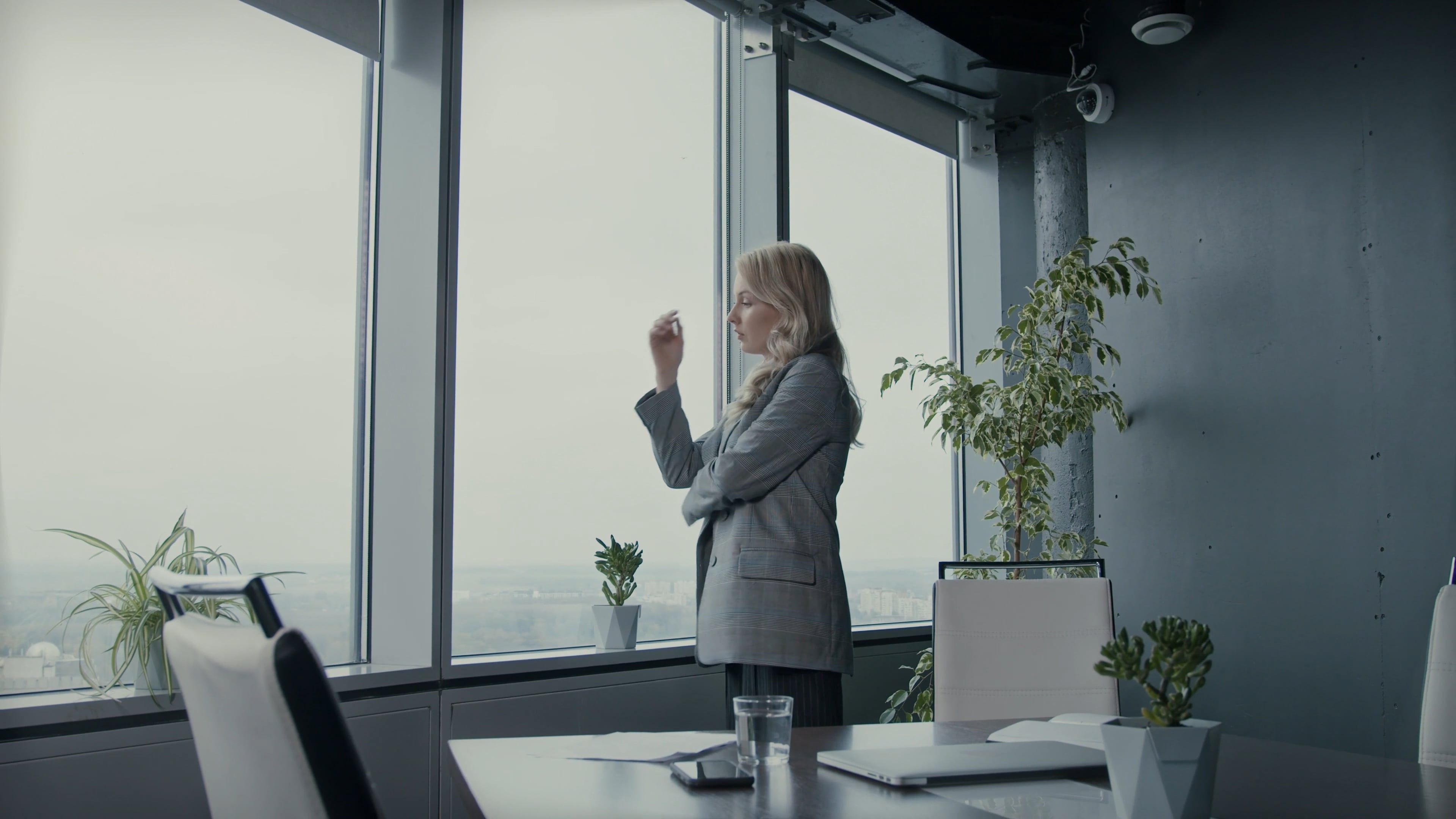 A Female Boss Looking Outside Of Her Office Window · Free Stock Video