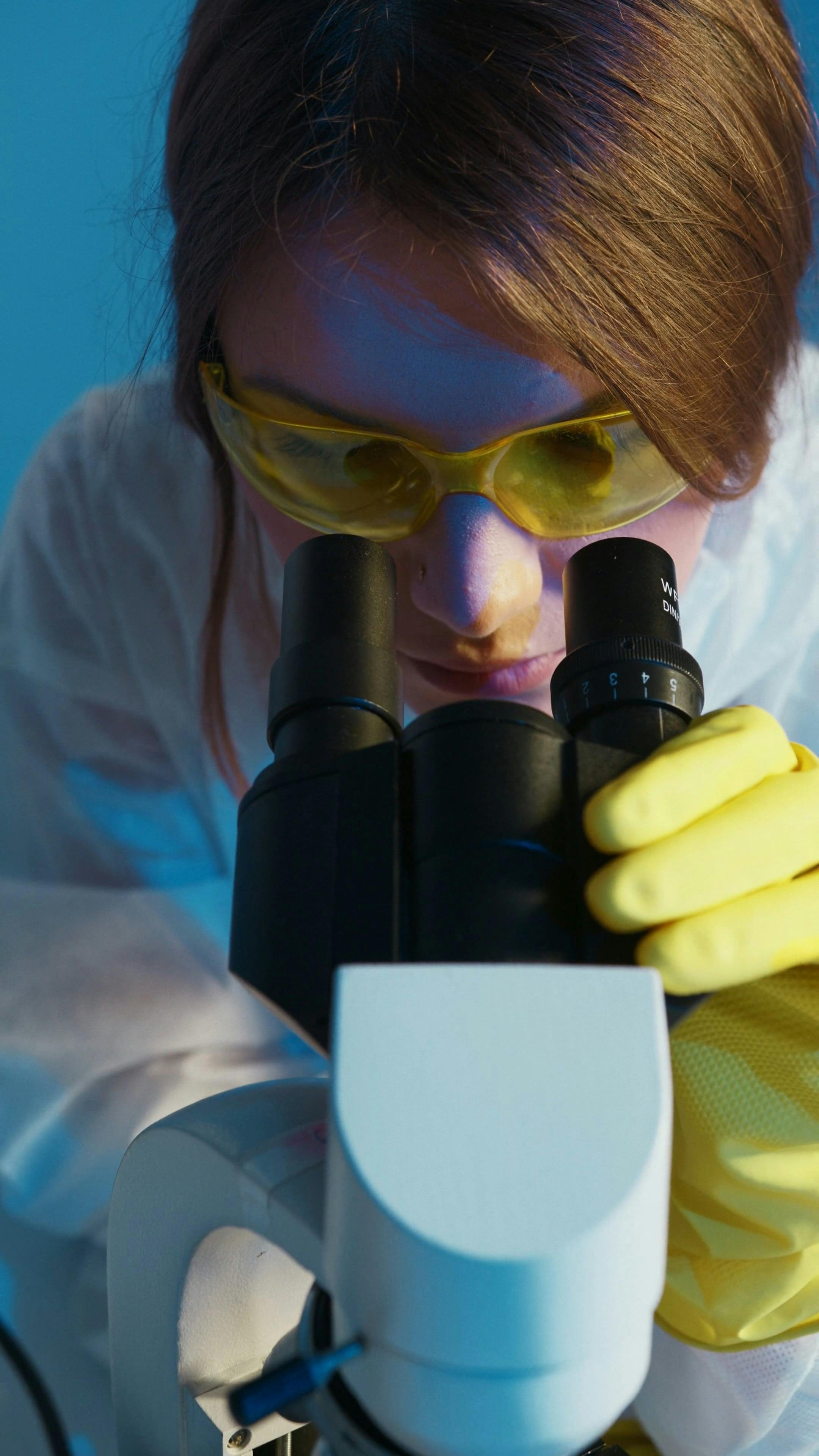 A Woman Looking Through the Microscope · Free Stock Video