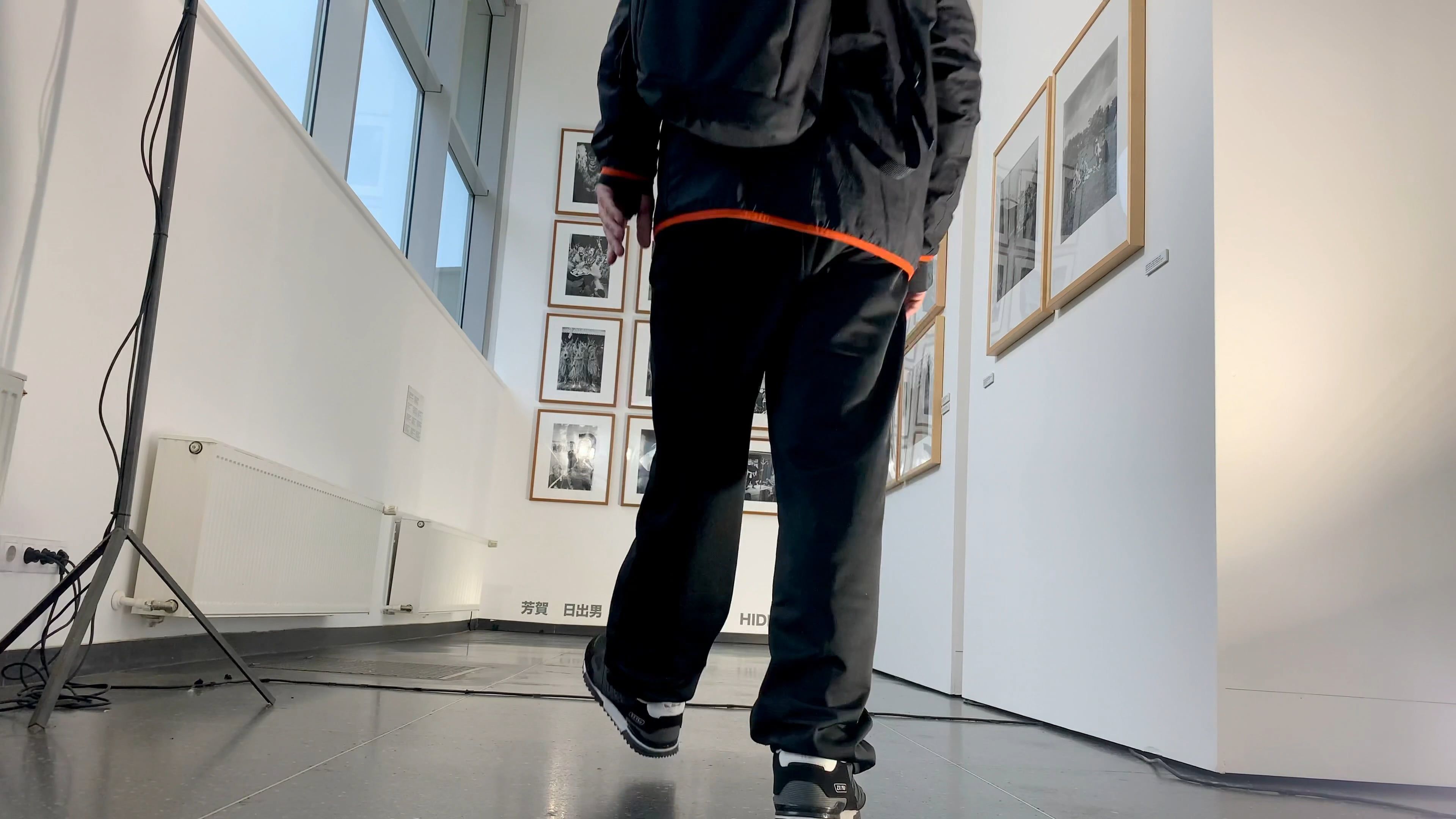 Man Walking Through a Hallway of a Photo Exhibit · Free Stock Video